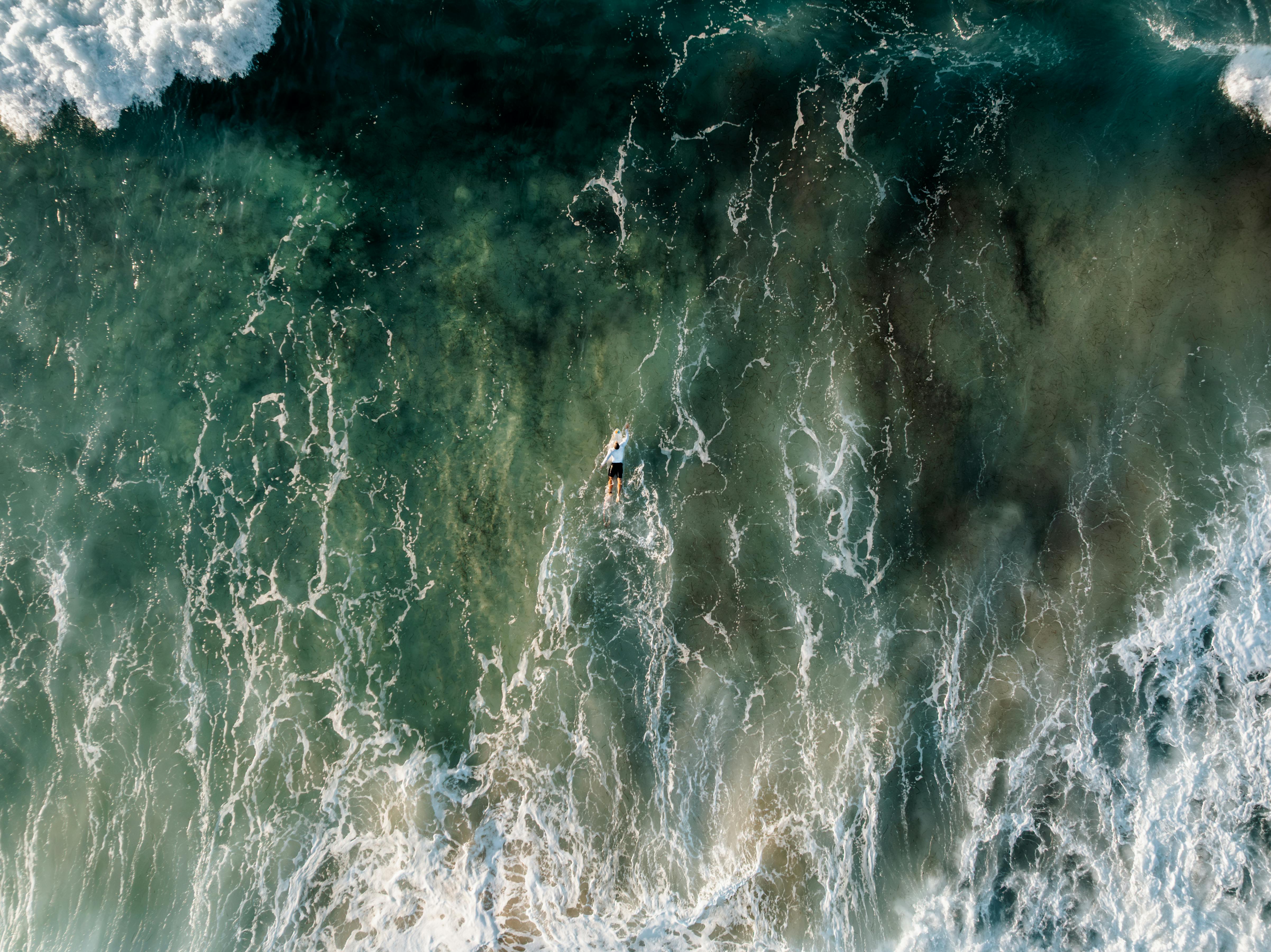 Aerial View of Surfer in Ocean Waves · Free Stock Photo