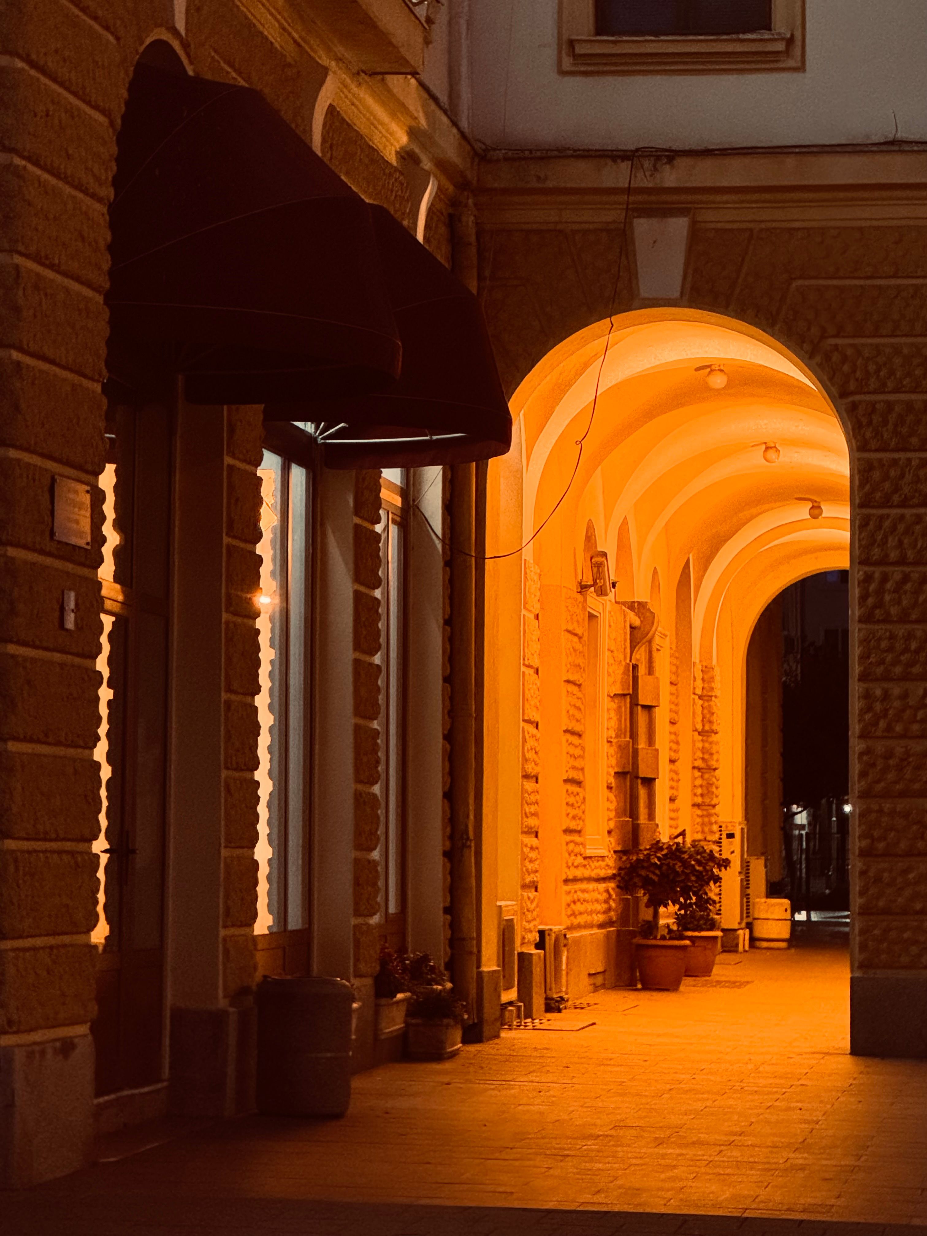 Cozy Nighttime European Archway Scene · Free Stock Photo