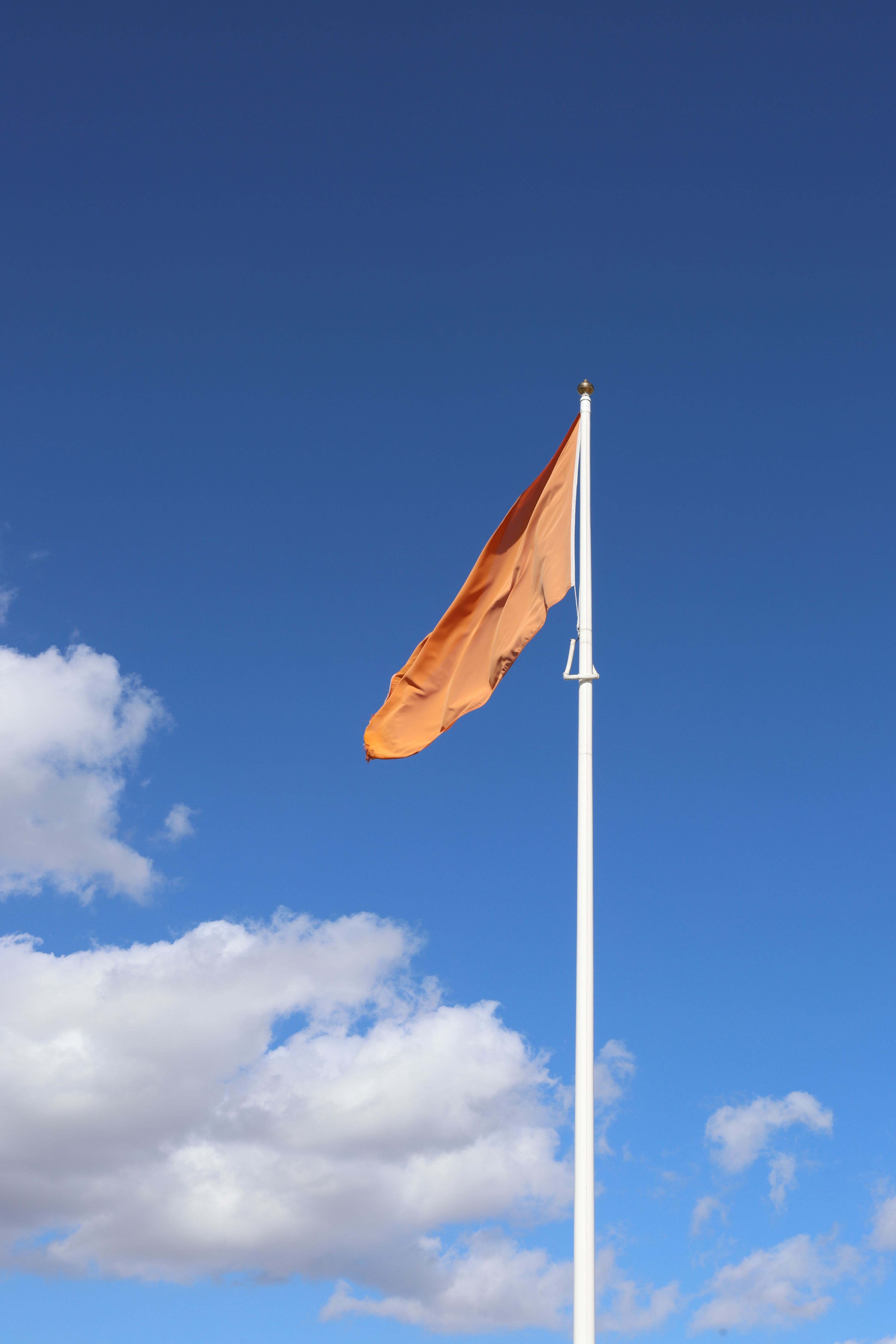 Orange Flag Against a Clear Blue Sky in Cleethorpes · Free Stock Photo