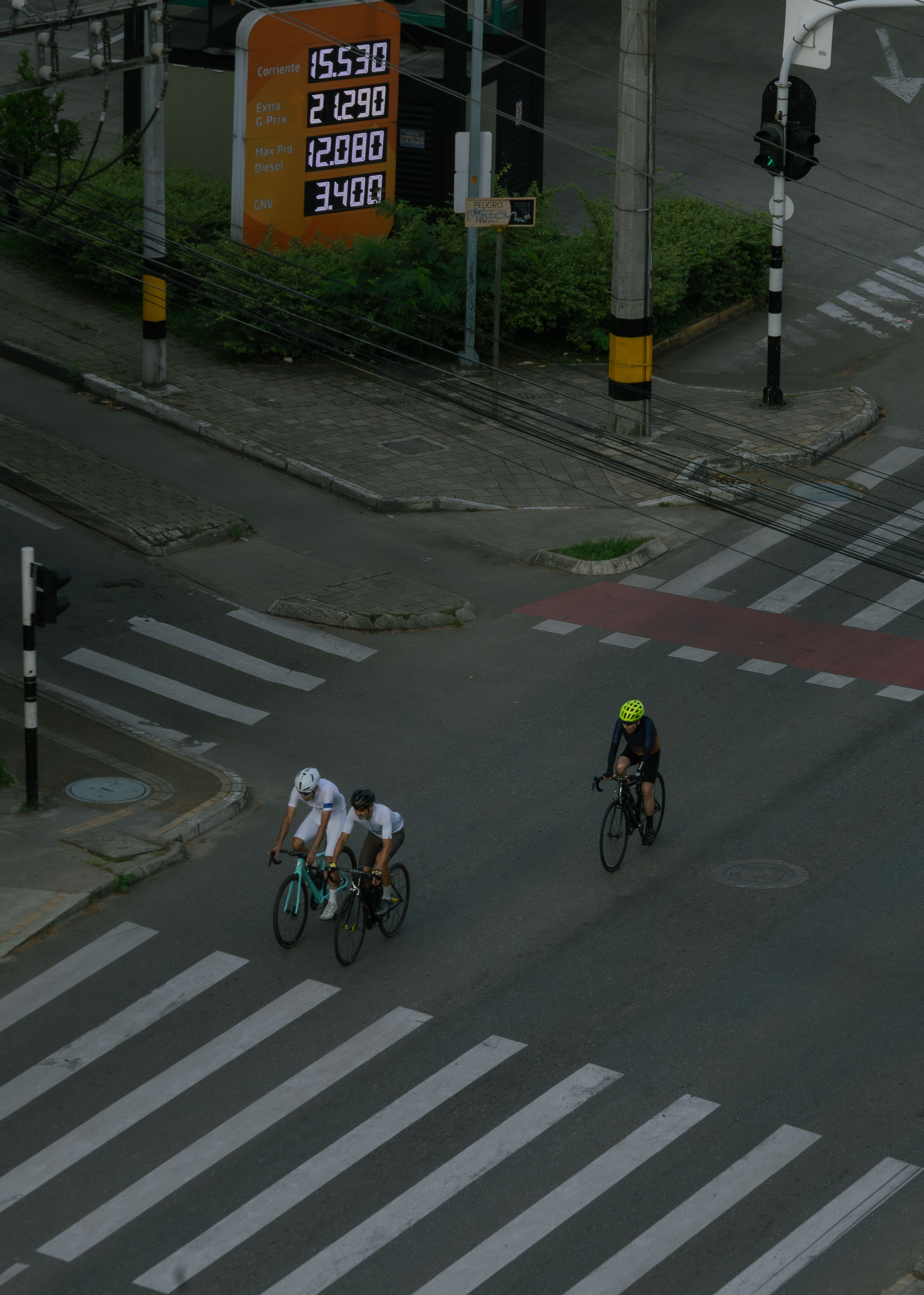 Cyclists on Medellín Street Crossing Intersection · Free Stock Photo