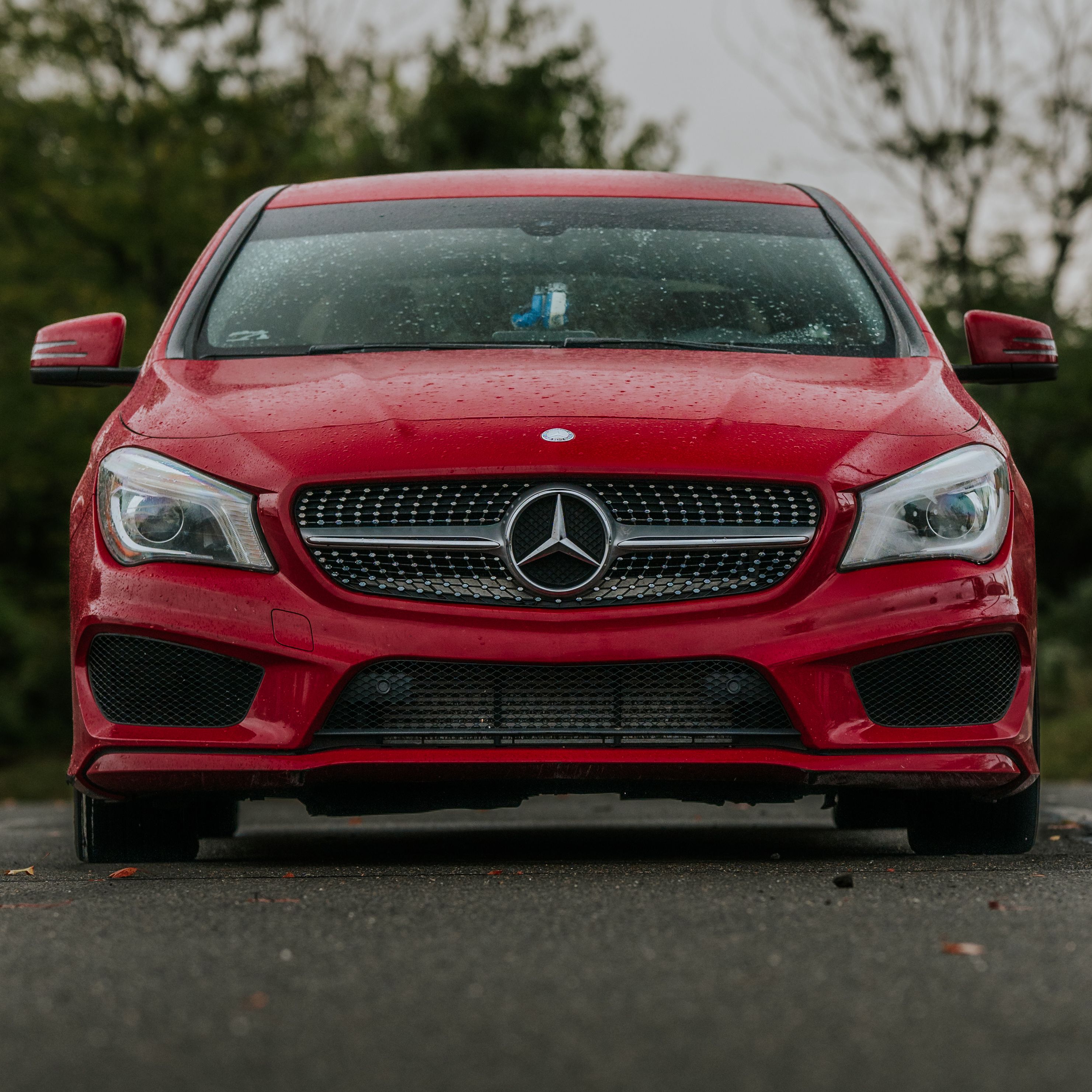 Bold Red Mercedes-Benz Front View on Wet Surface · Free Stock Photo