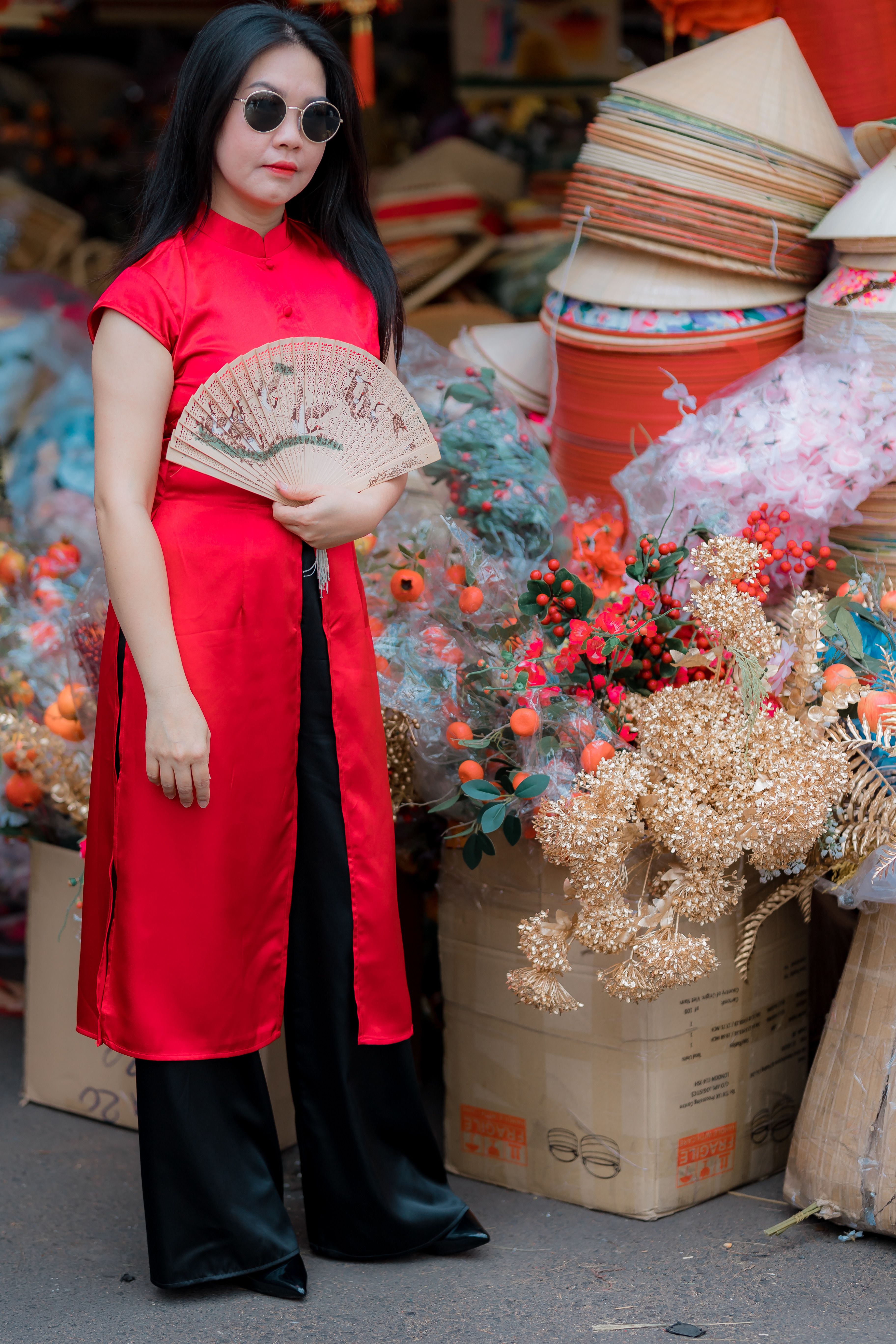 Woman in Traditional Red Dress with Fan in Market · Free Stock Photo