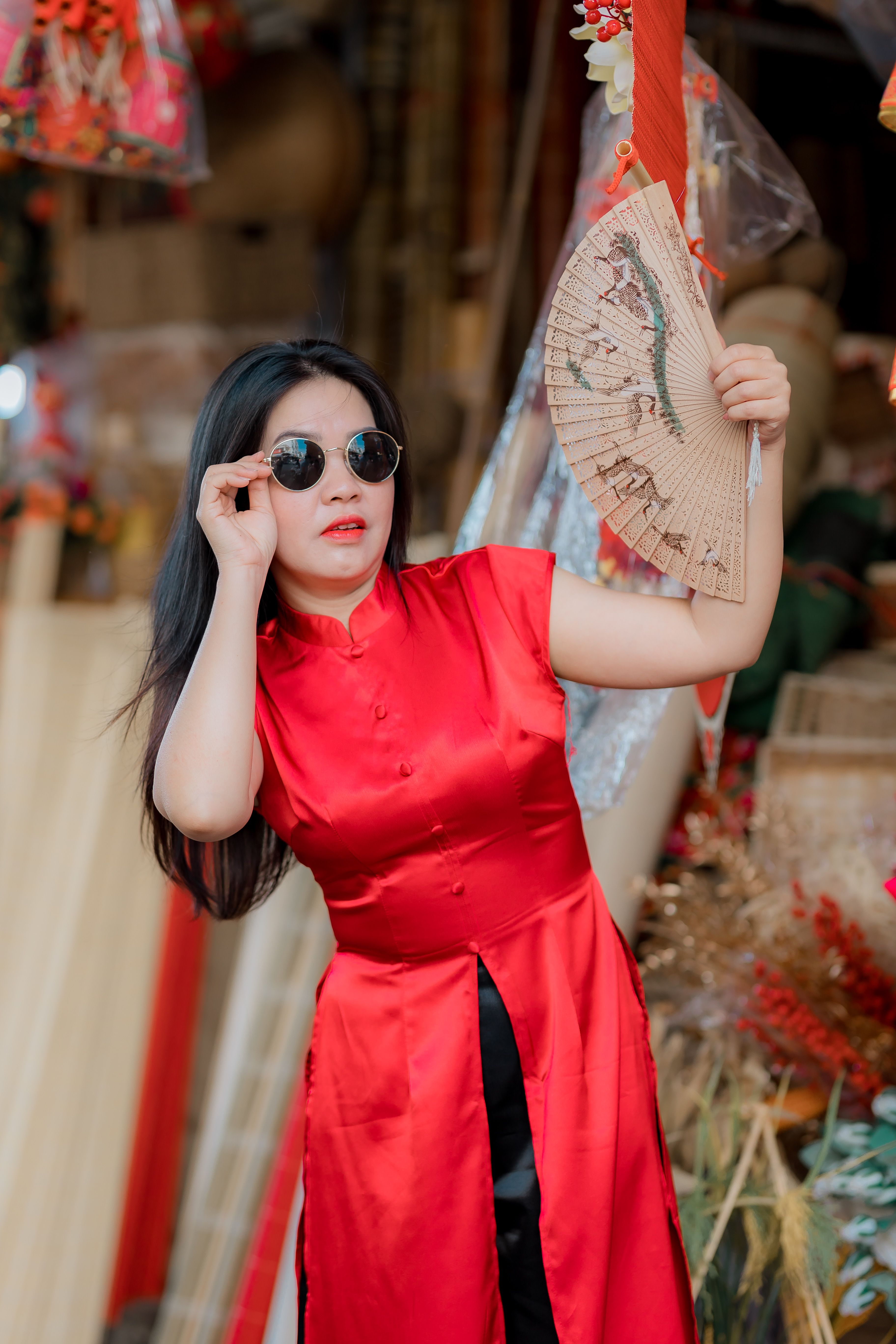 Woman in Red Cheongsam Holding Fan with Sunglasses · Free Stock Photo