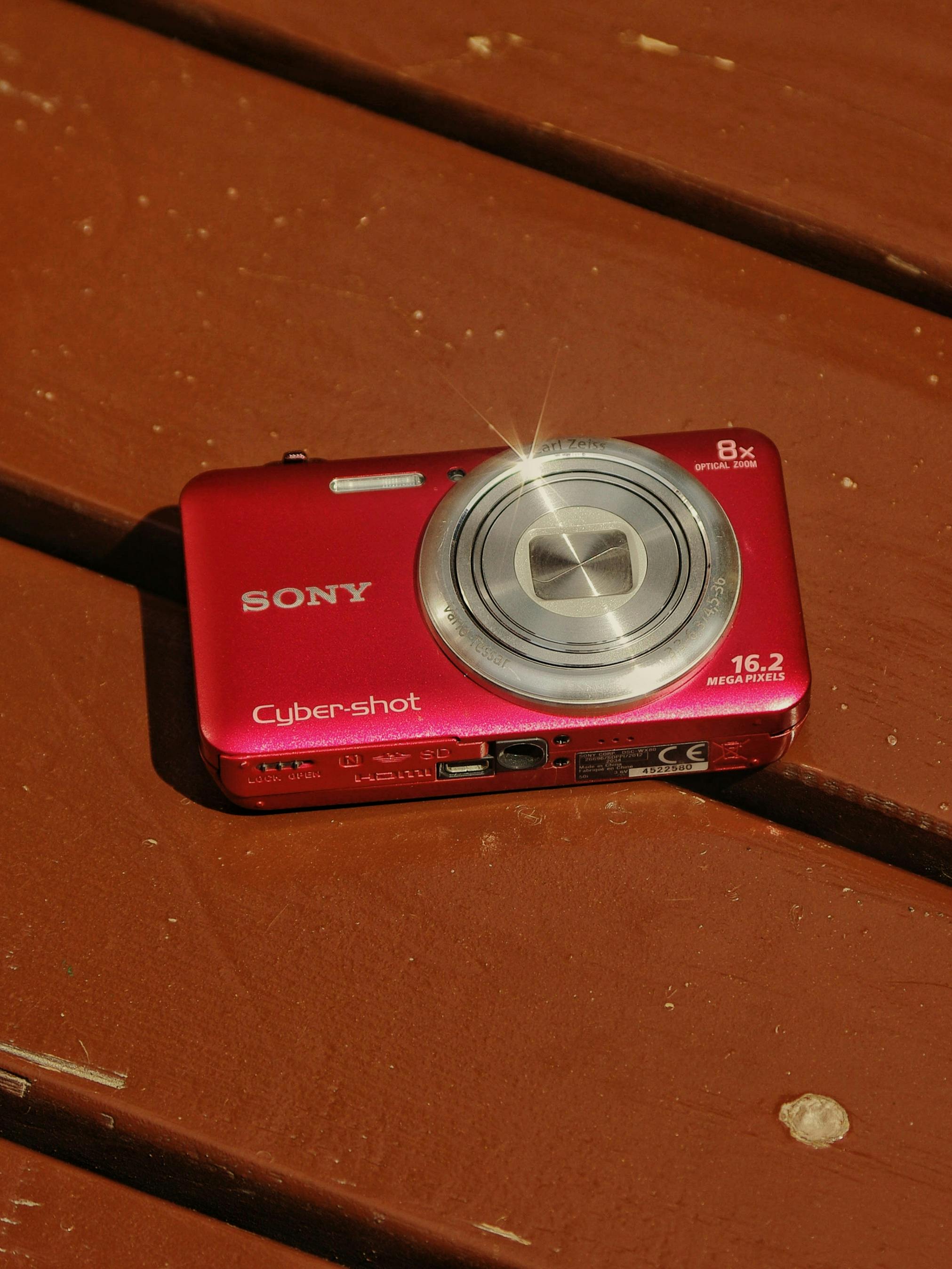 Red Digital Camera on Wooden Surface · Free Stock Photo