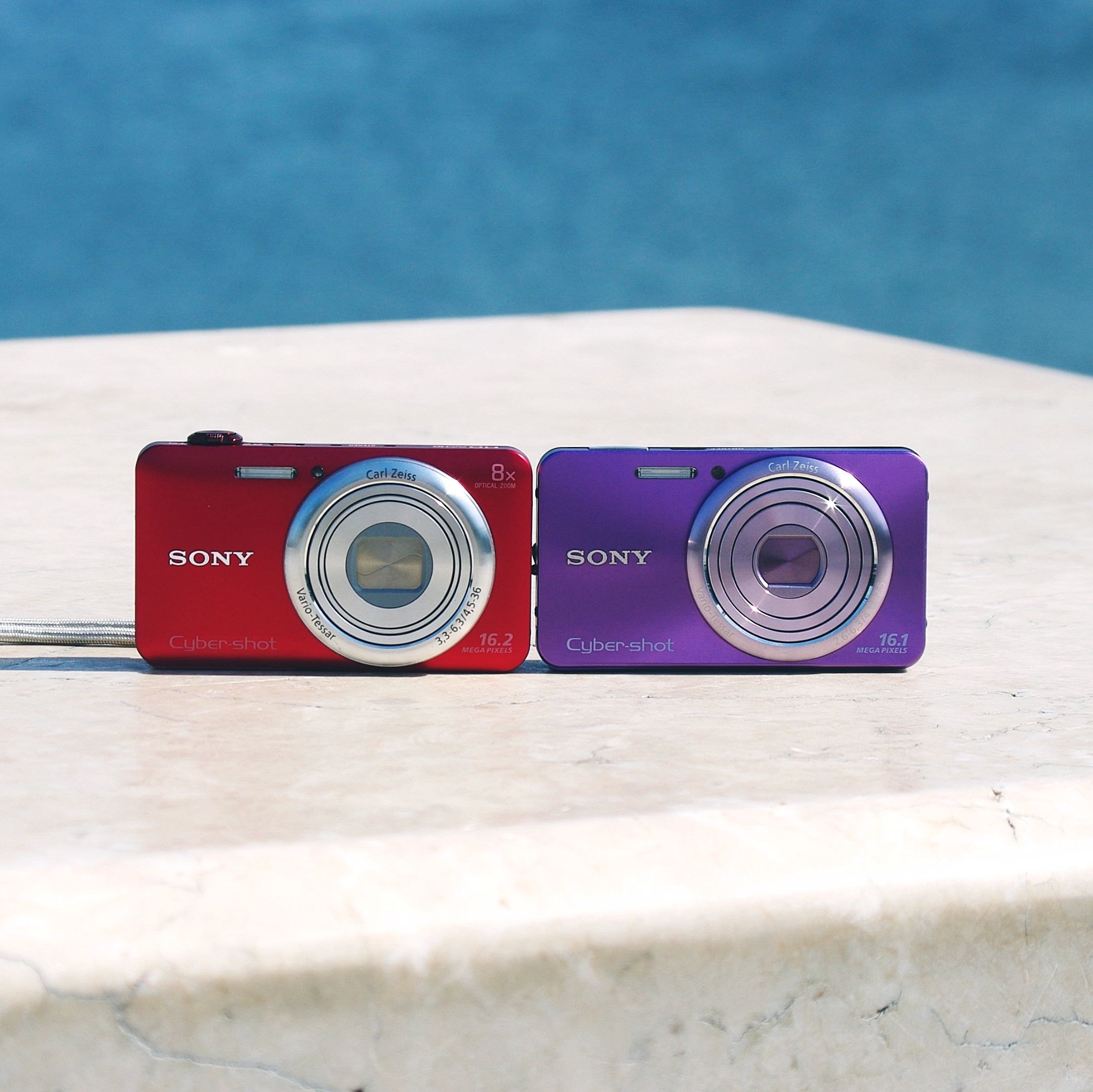 Colorful Digital Cameras on Marble Surface · Free Stock Photo