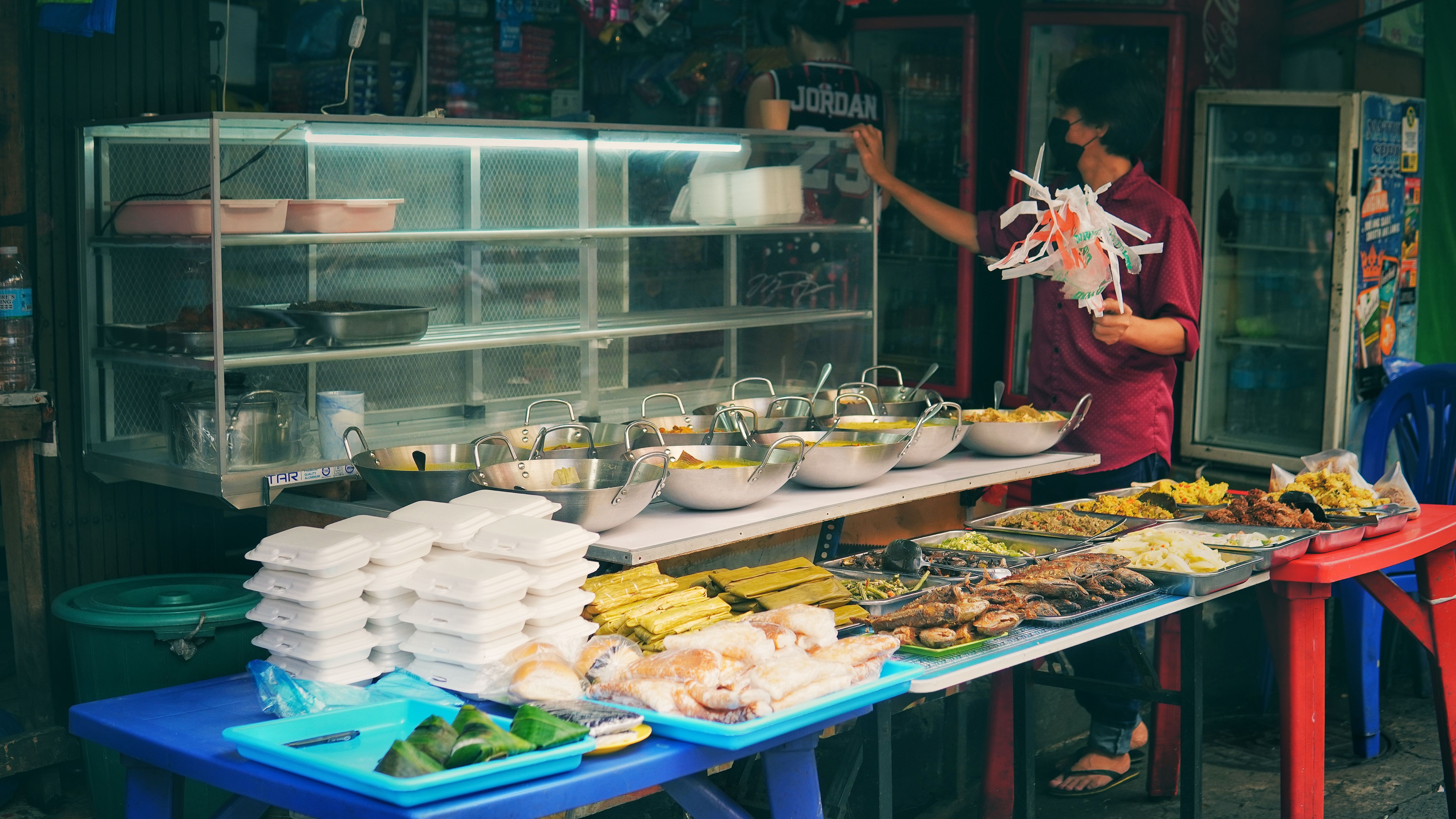 Street Food Vendor Stall with Various Dishes · Free Stock Photo
