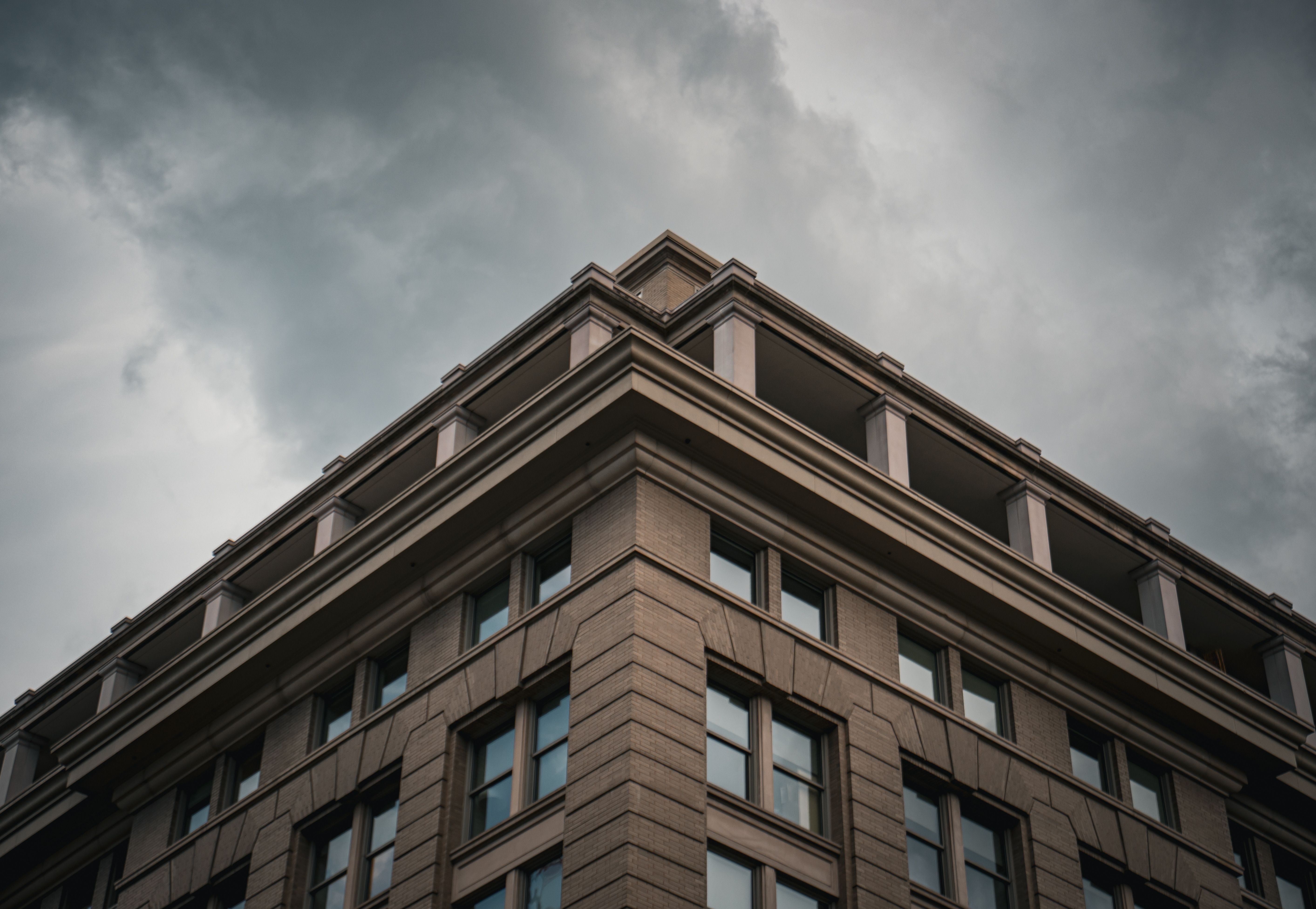 Dramatic Urban Architecture Against Moody Sky · Free Stock Photo