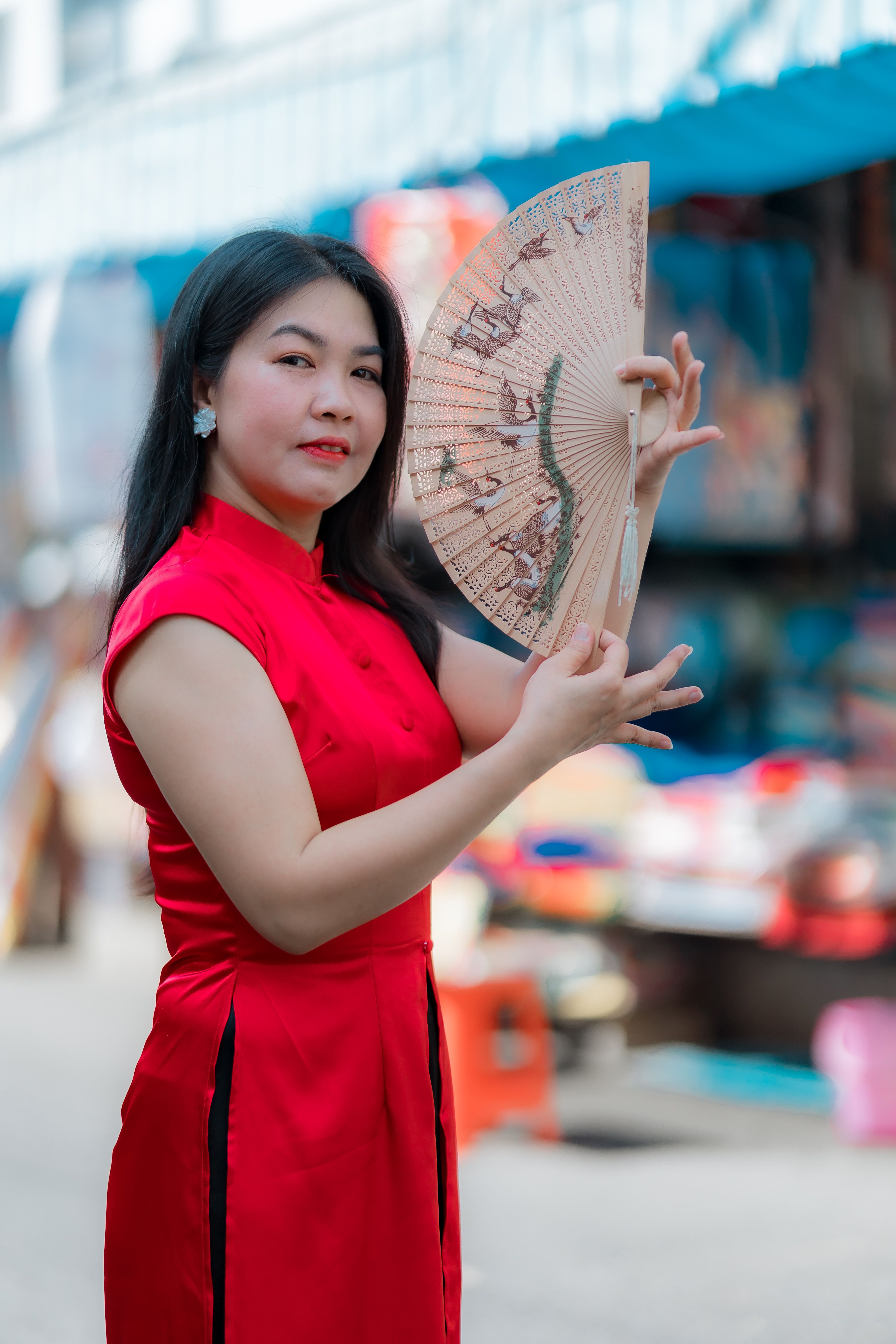 Woman in Red Dress Holding a Traditional Fan · Free Stock Photo