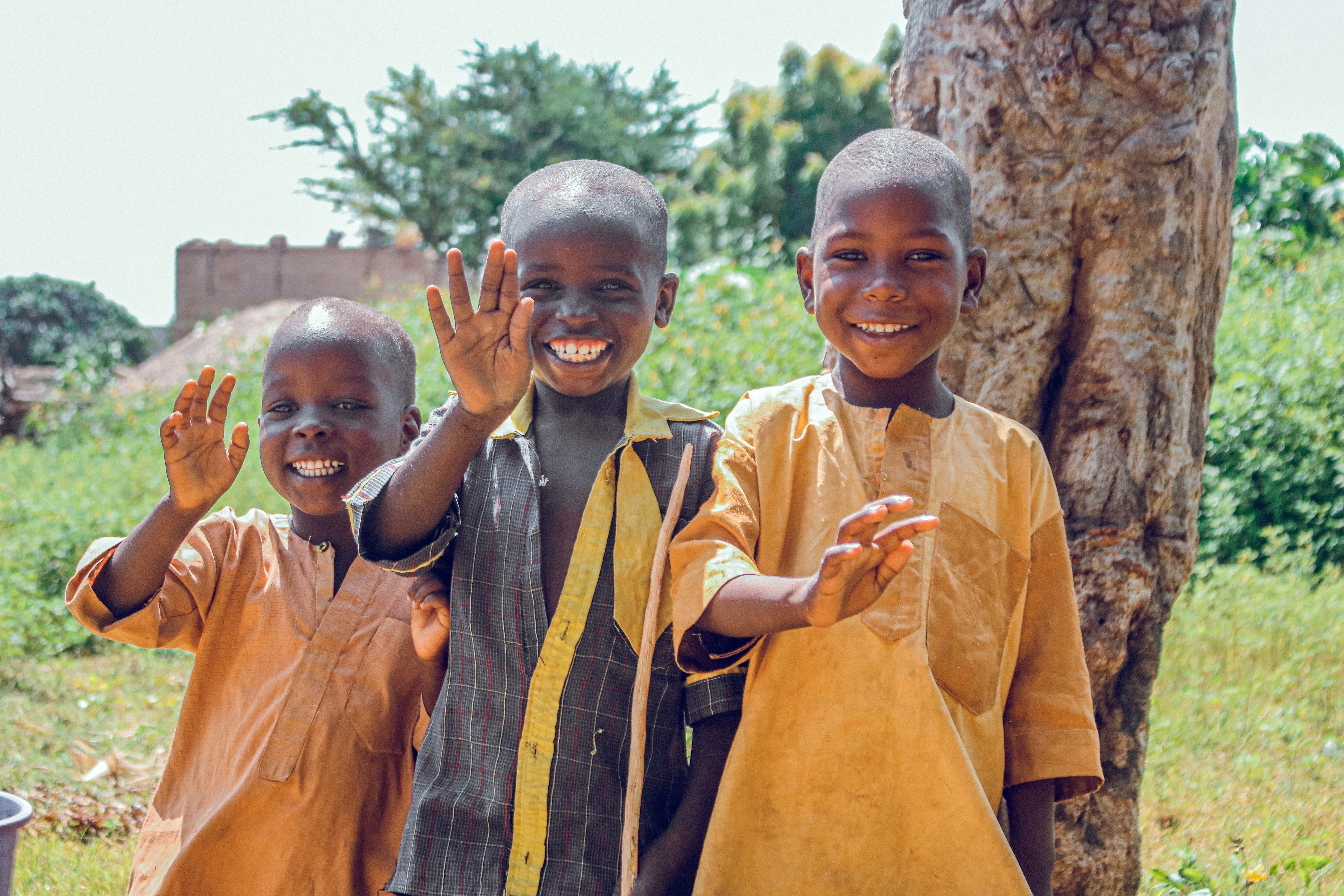 Smiling African Children Waving Outdoors in Summer · Free Stock Photo