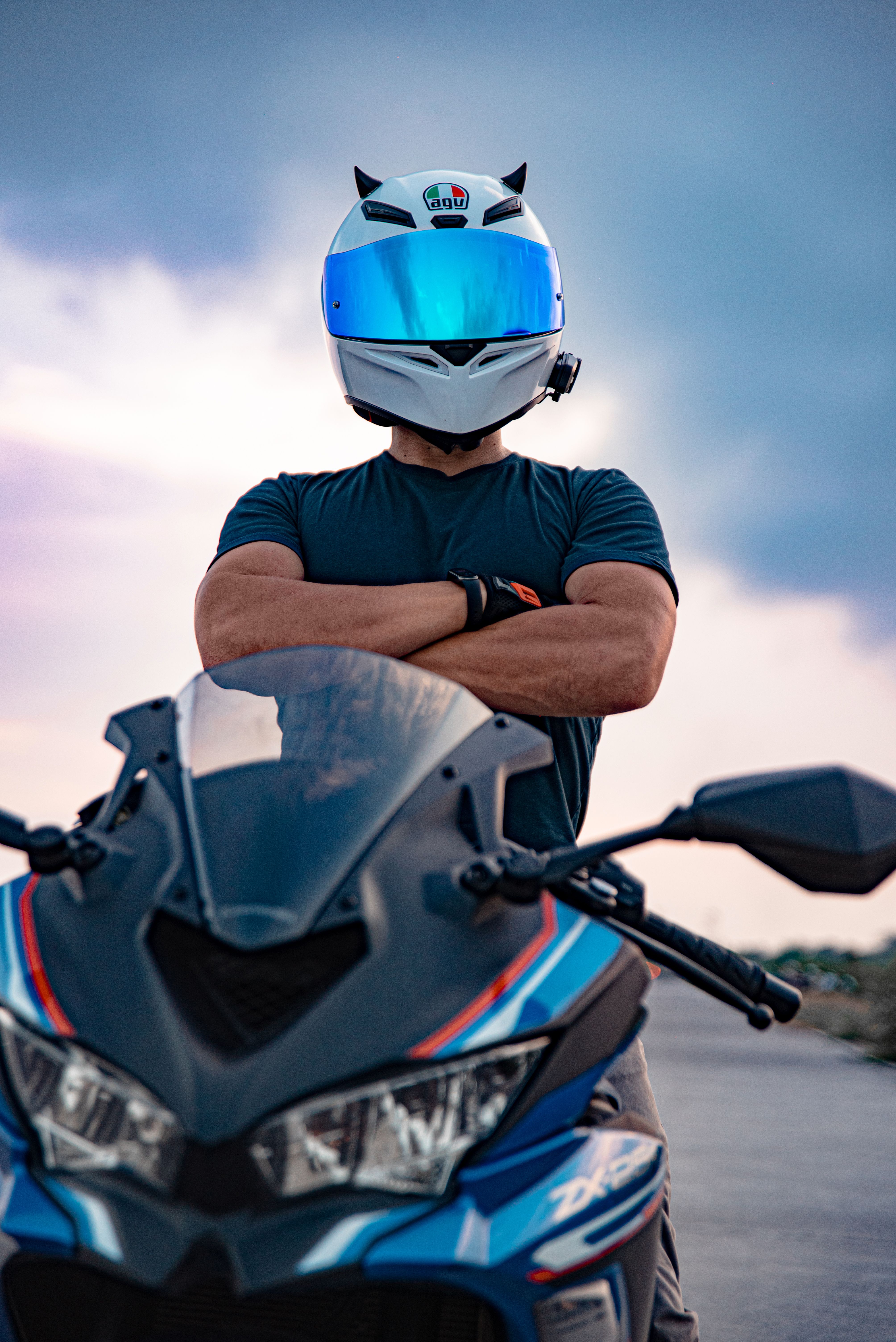 Motorcyclist with Helmet and Sport Bike at Sunset · Free Stock Photo