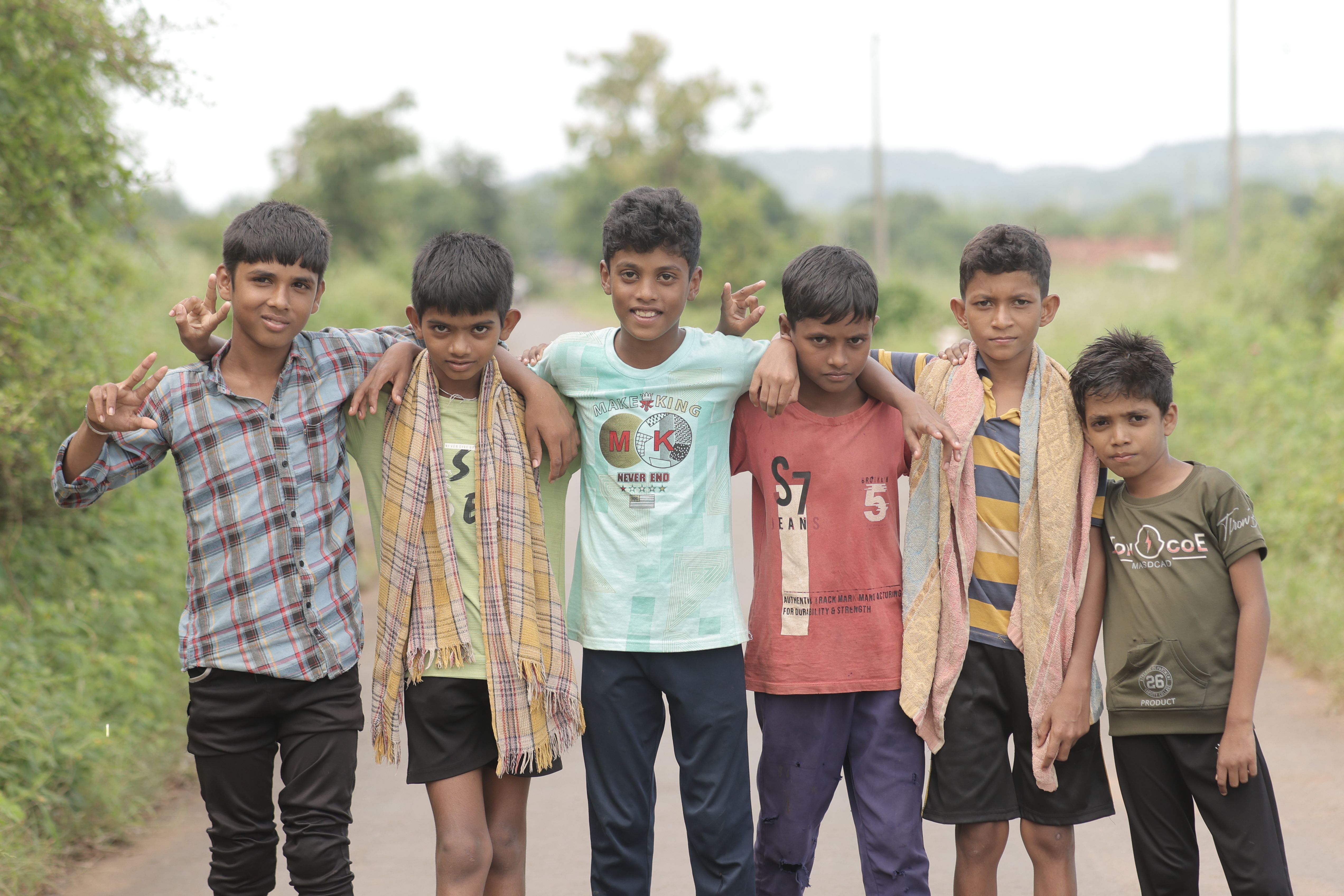 Group of Smiling Boys Posing on Rural Pathway · Free Stock Photo