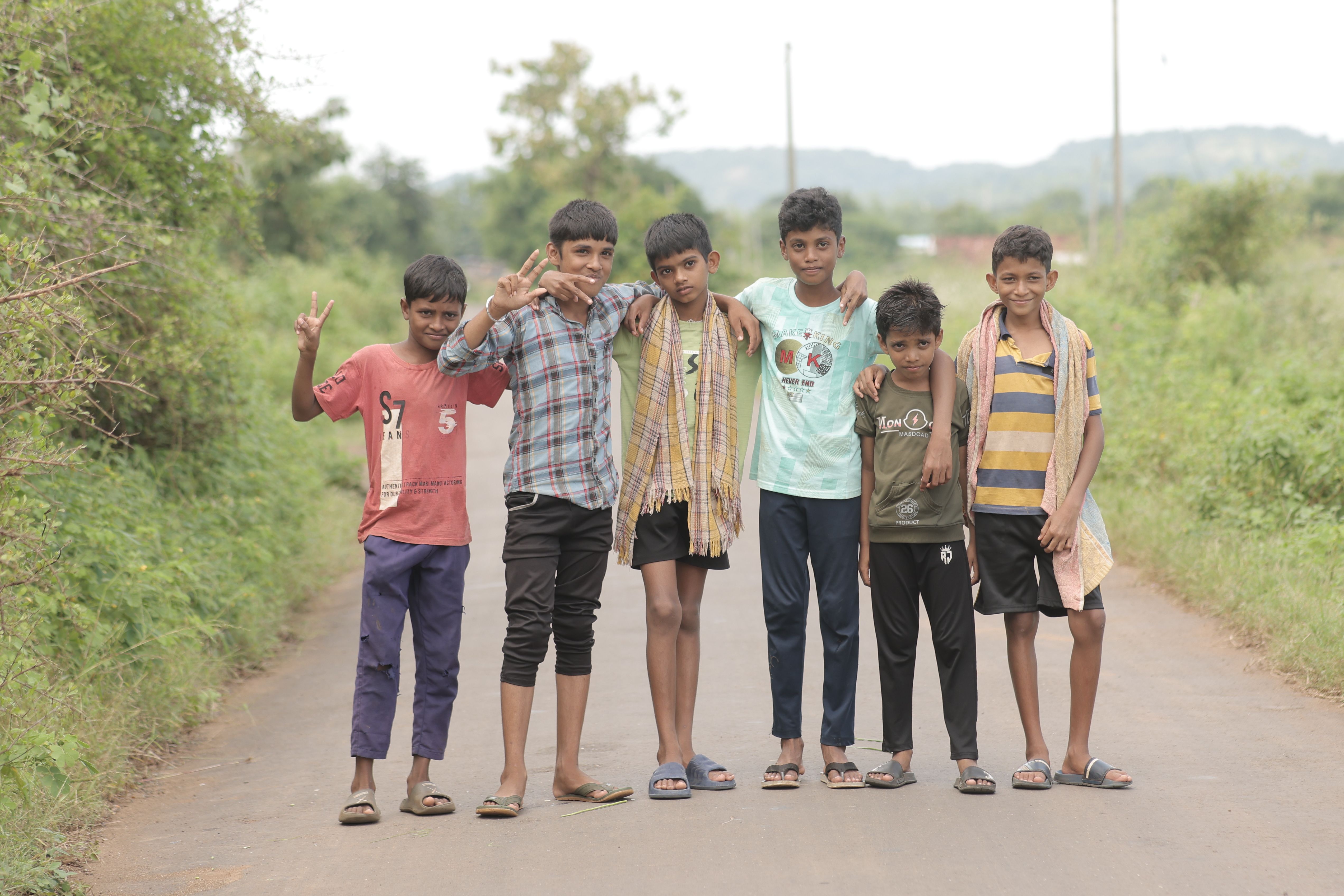 Group of Smiling Boys Posing on Rural Pathway · Free Stock Photo