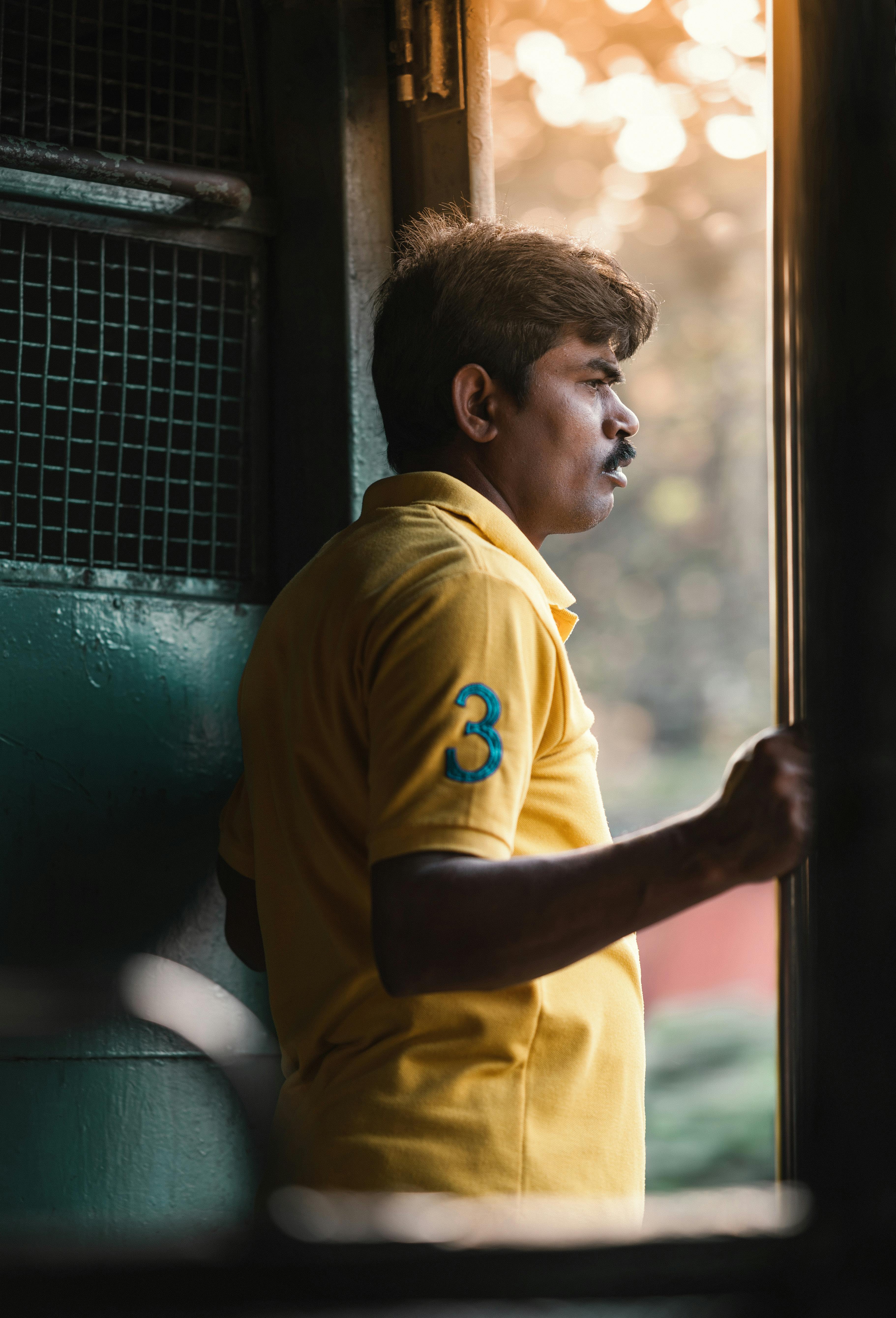 Man Gazing Out of Train Window in Kolkata · Free Stock Photo