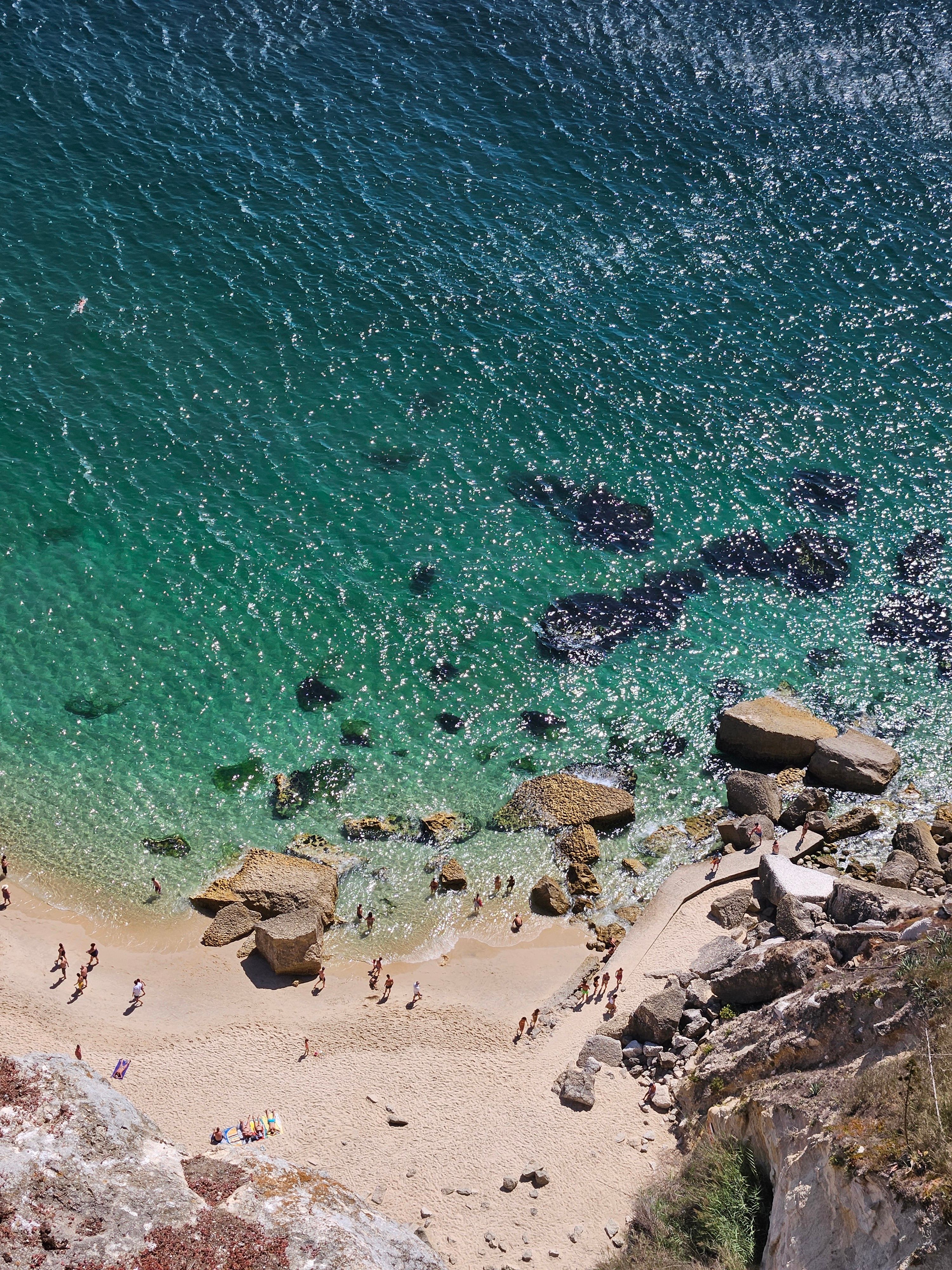 Aerial View of Scenic Beach with Rocky Shoreline · Free Stock Photo