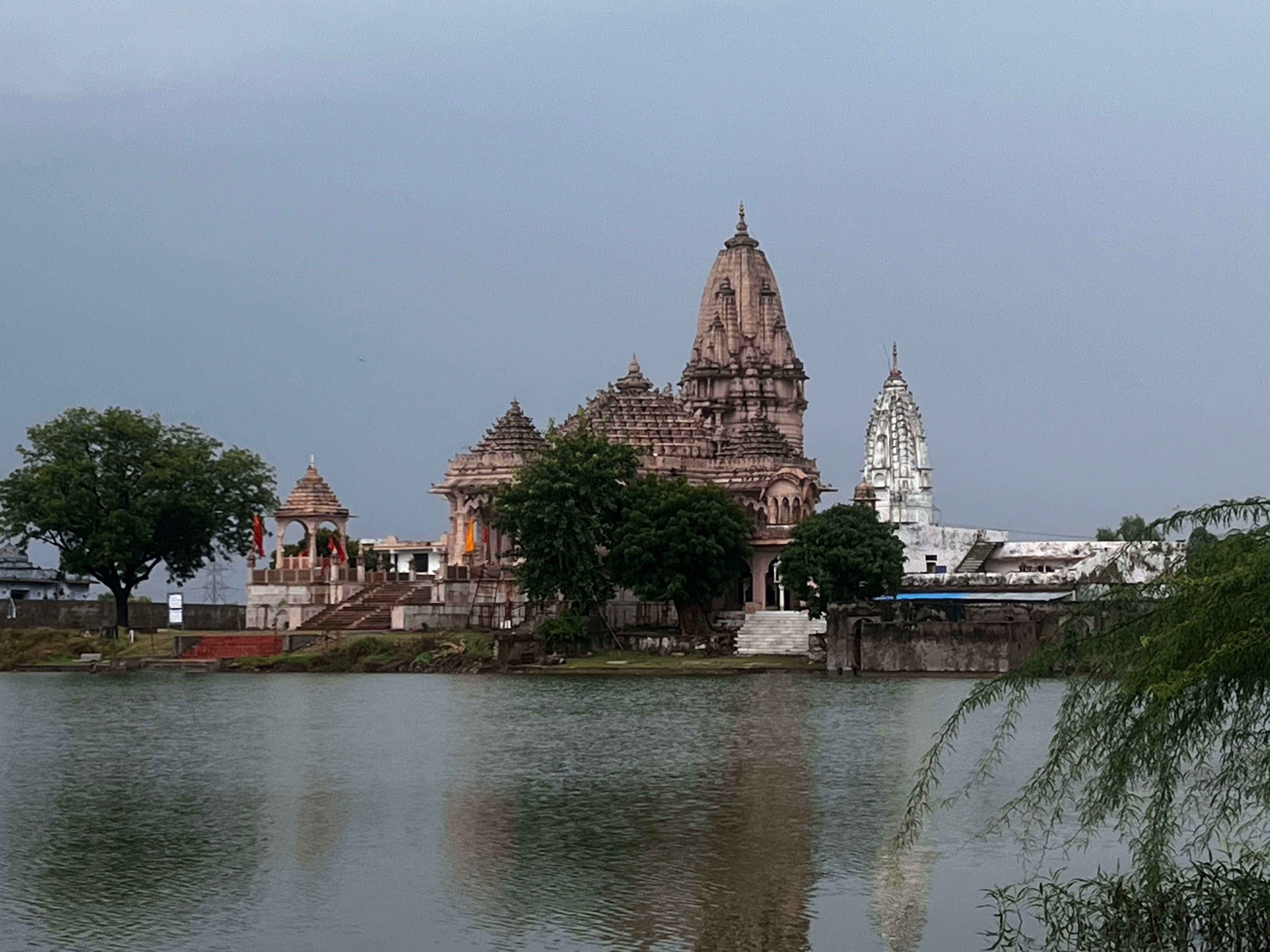 Historic Hindu Temple by Lake Under Clear Sky · Free Stock Photo