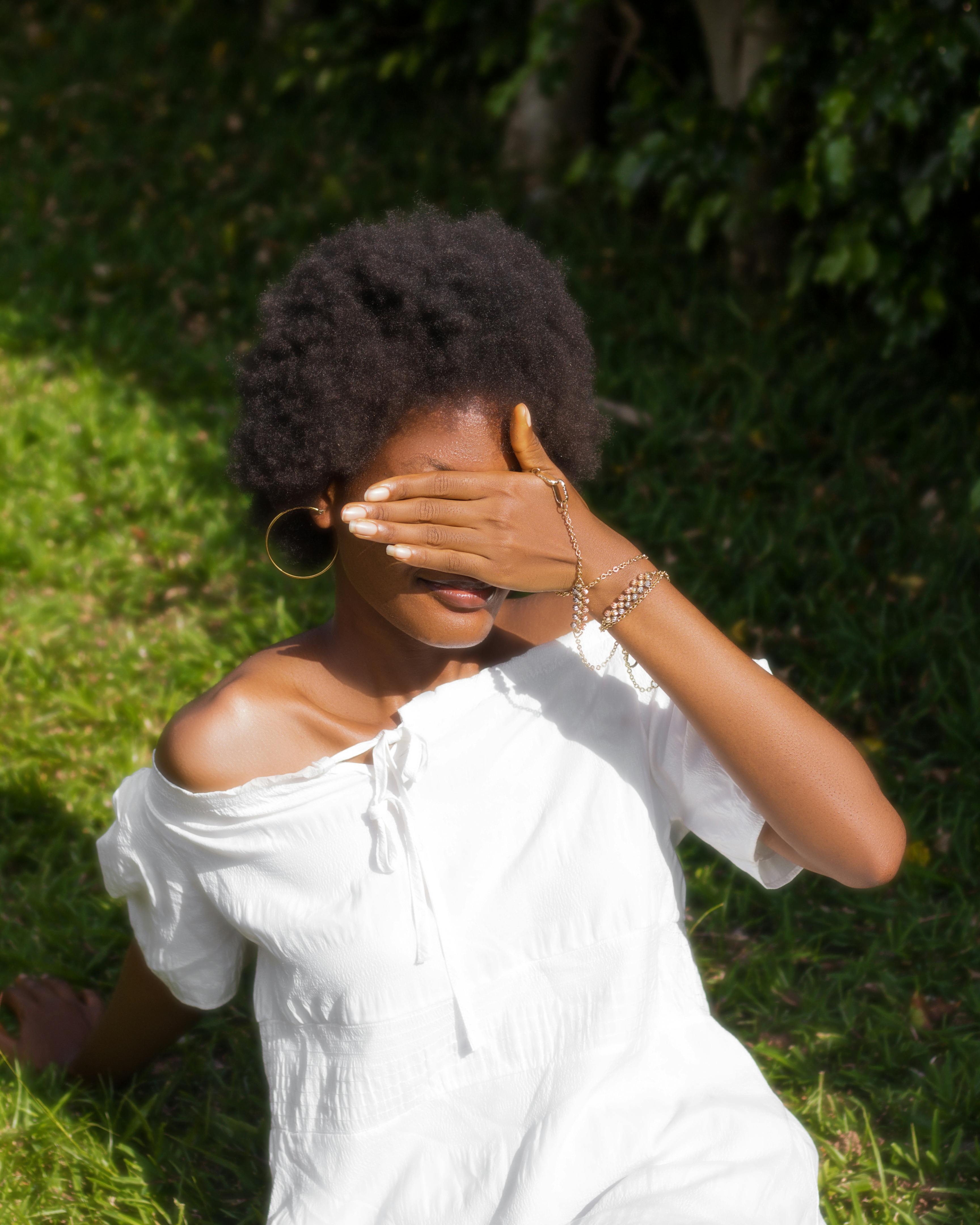 Woman Relaxing Outdoors with Hand Over Face · Free Stock Photo