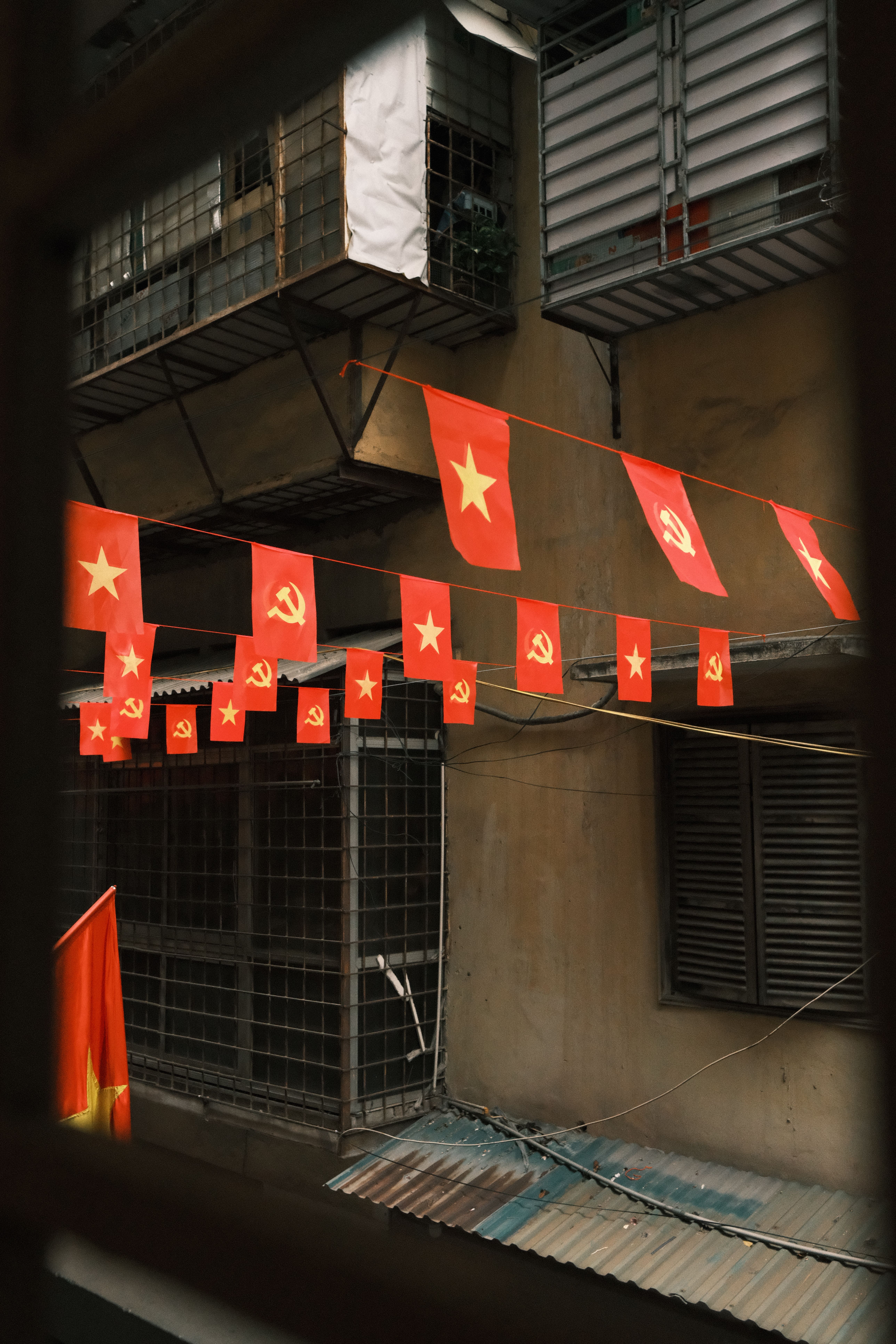 Communist Flags Displayed in Urban Courtyard · Free Stock Photo