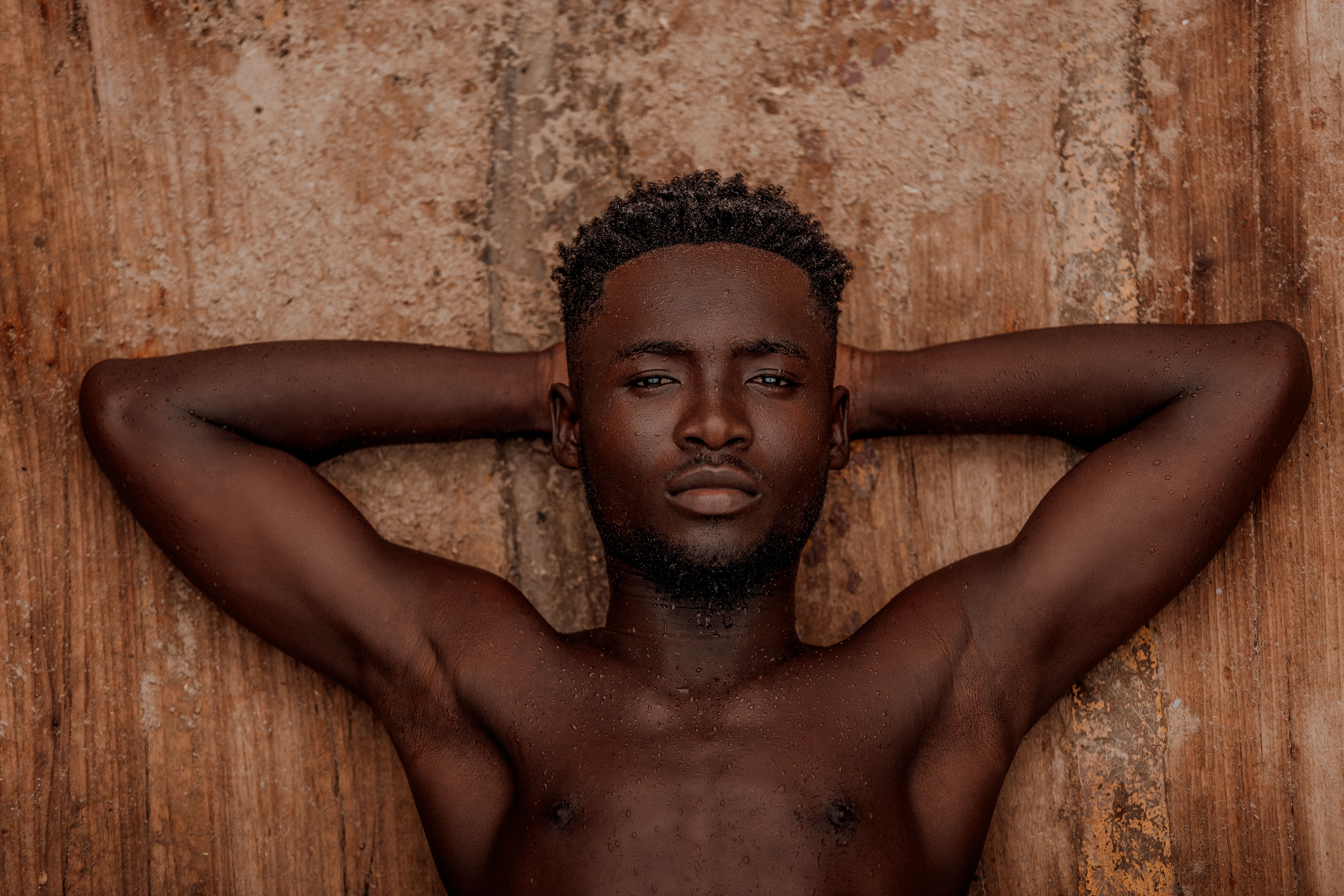 Relaxed Portrait of a Young Man Against Rustic Background · Free Stock ...