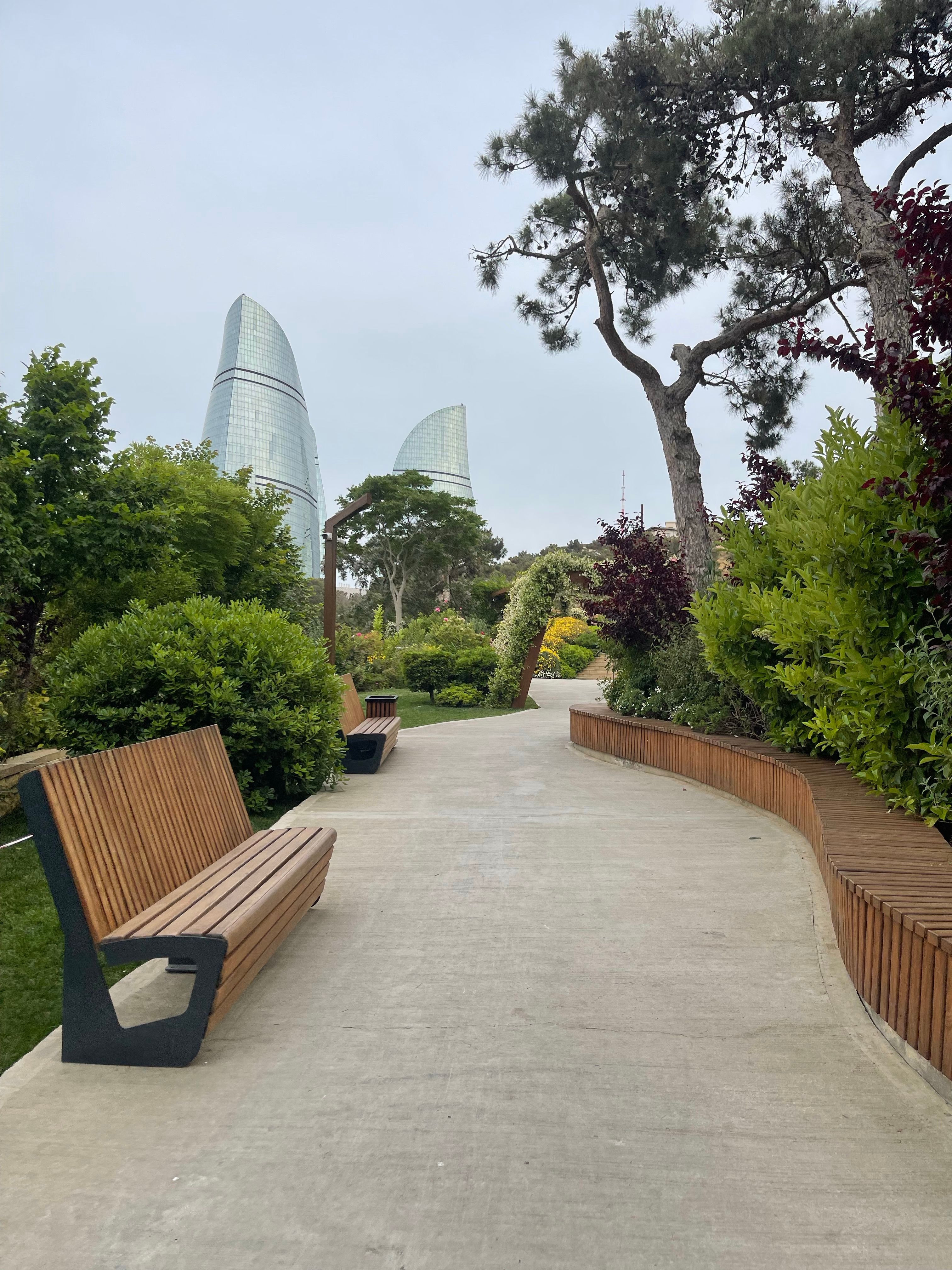 Scenic Park Pathway with Modern Architecture · Free Stock Photo