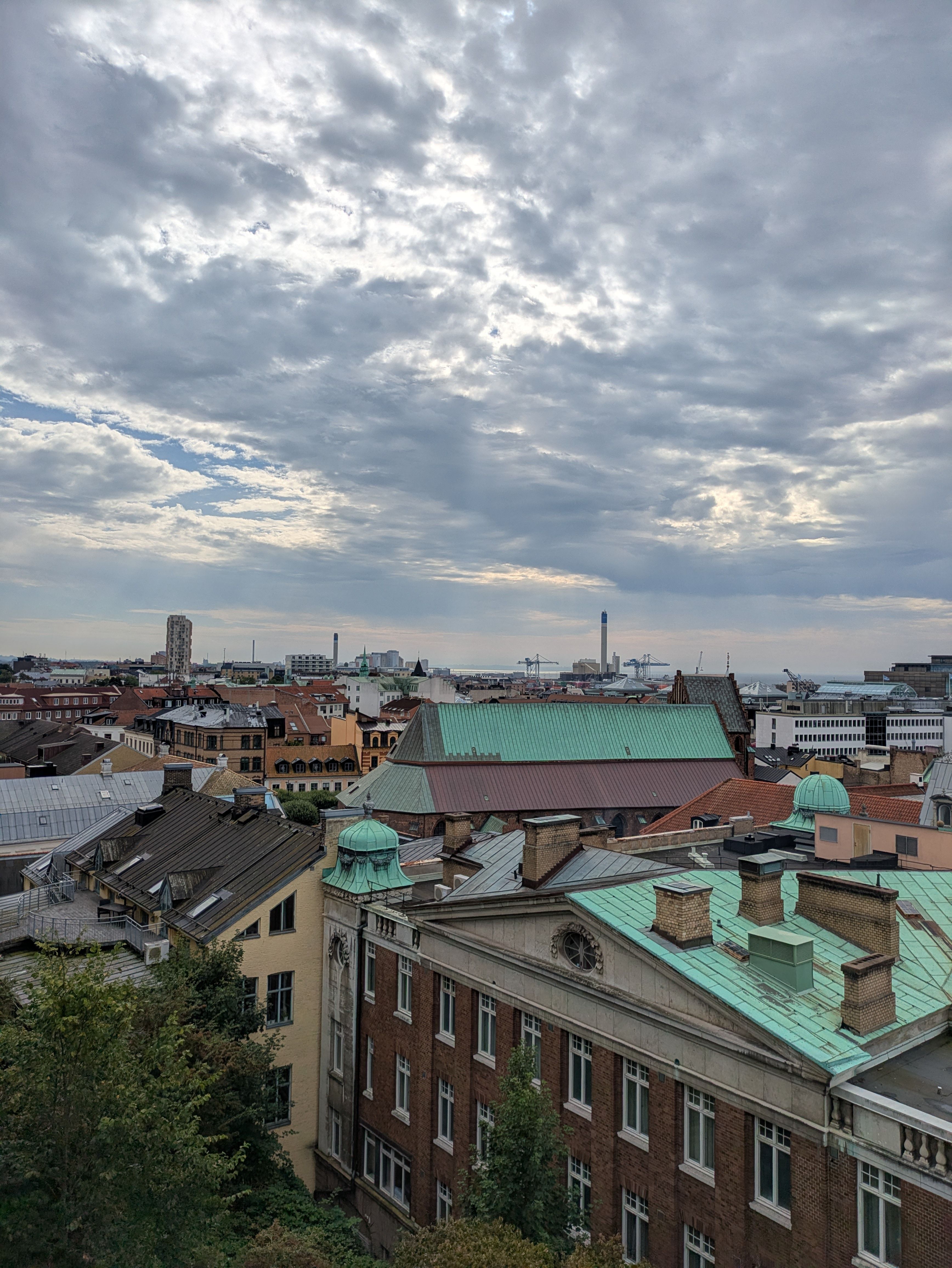 Scenic Urban Rooftop View with Cloudy Sky · Free Stock Photo
