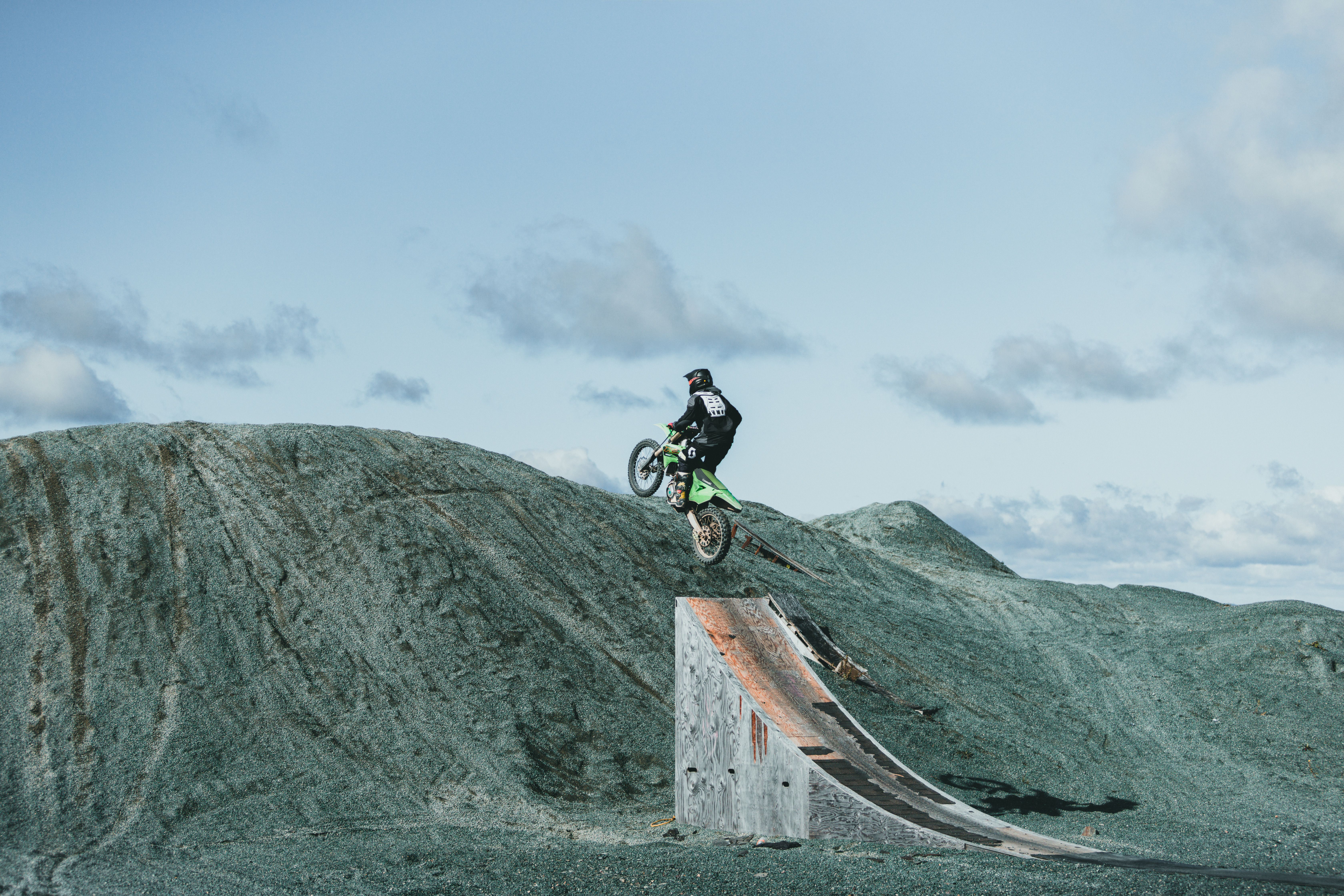 Motorcyclist Performing Jump on Dirt Ramp · Free Stock Photo