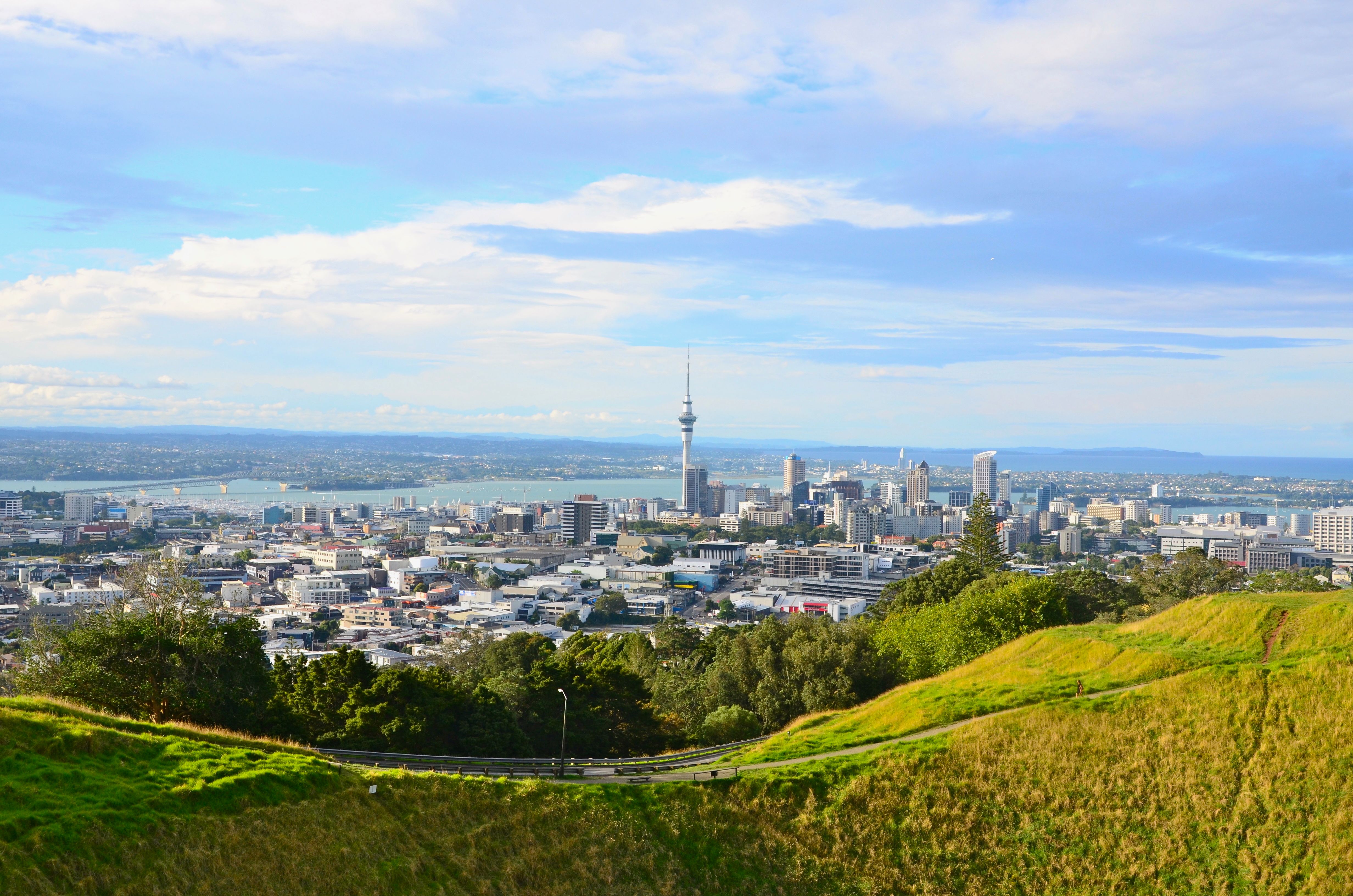 Auckland Skyline with Sky Tower and Green Hills · Free Stock Photo