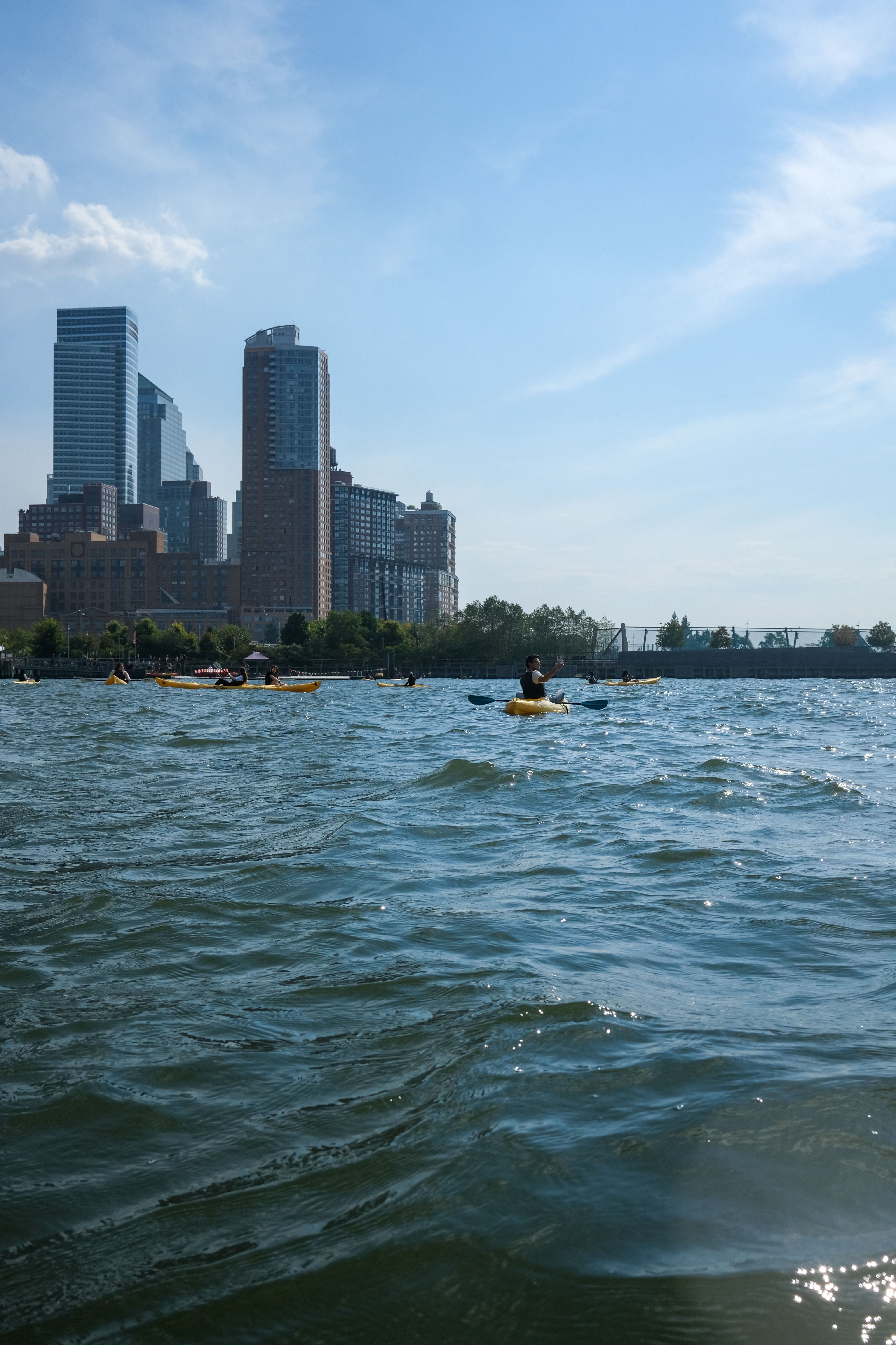 Kayaking Adventure Near Urban Skyline · Free Stock Photo