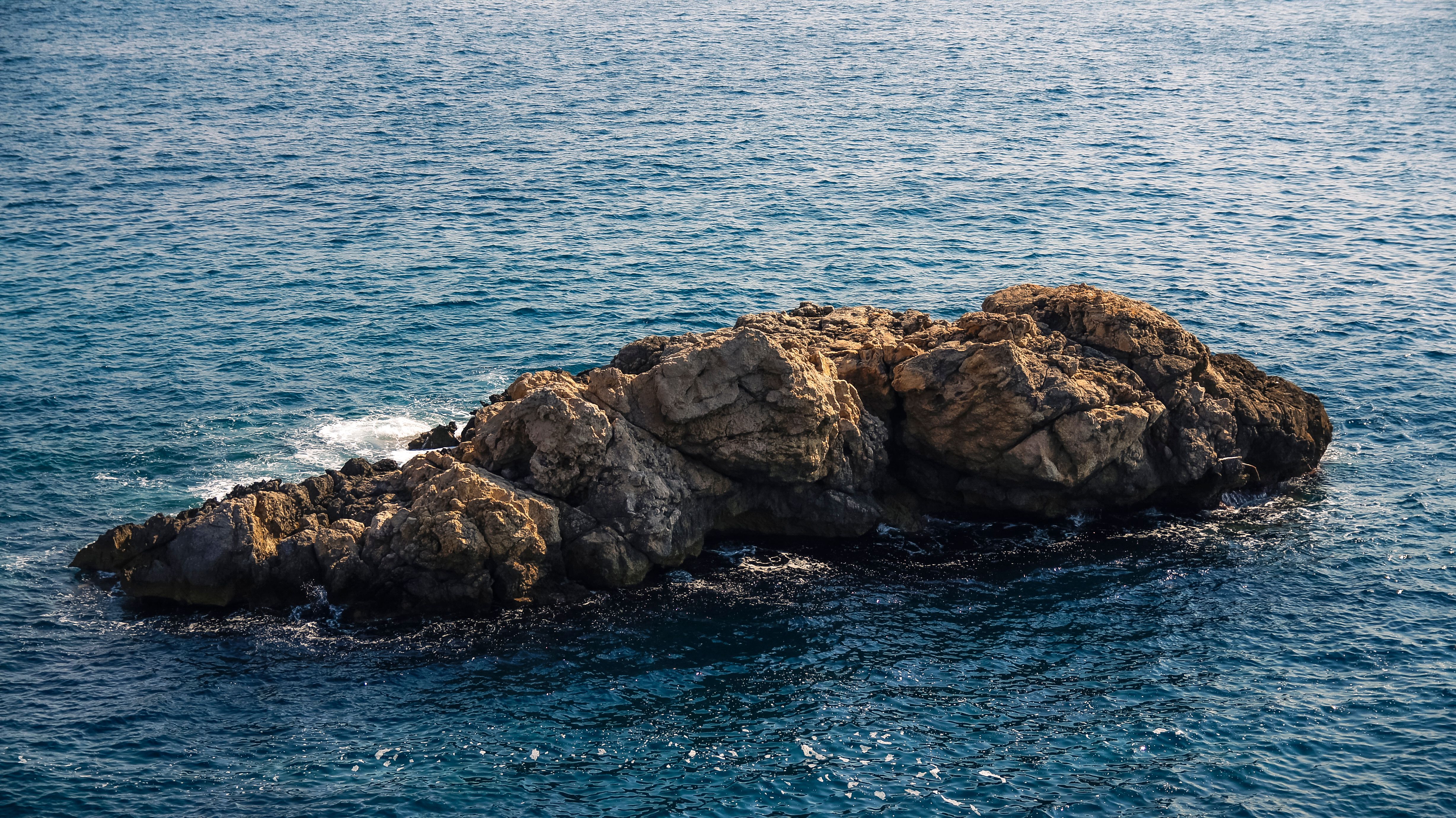 Rocky Outcrop in the Ocean at Daytime · Free Stock Photo