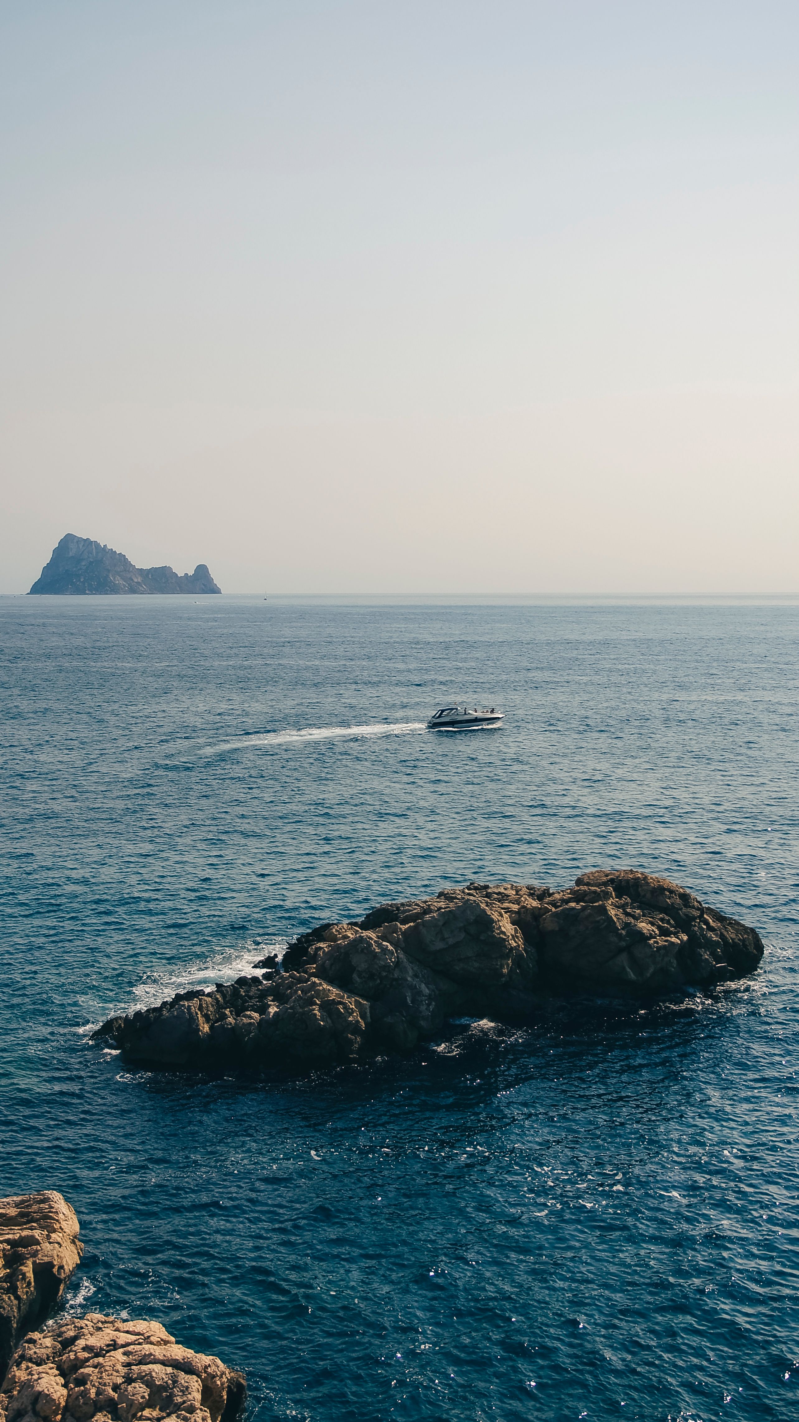 Serene Boat Ride Along Rocky Coastline · Free Stock Photo