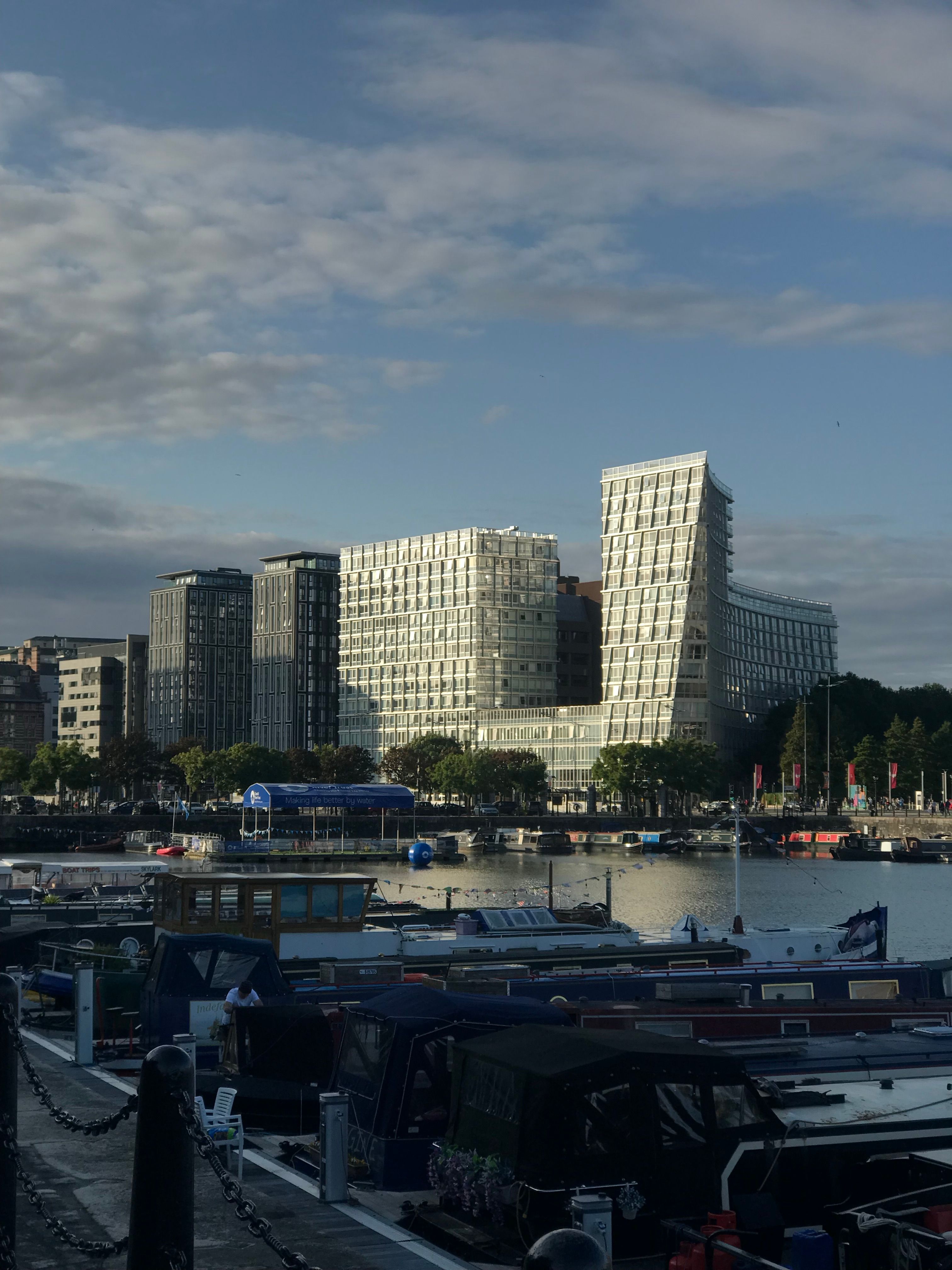 Modern Architecture by River with Boats · Free Stock Photo