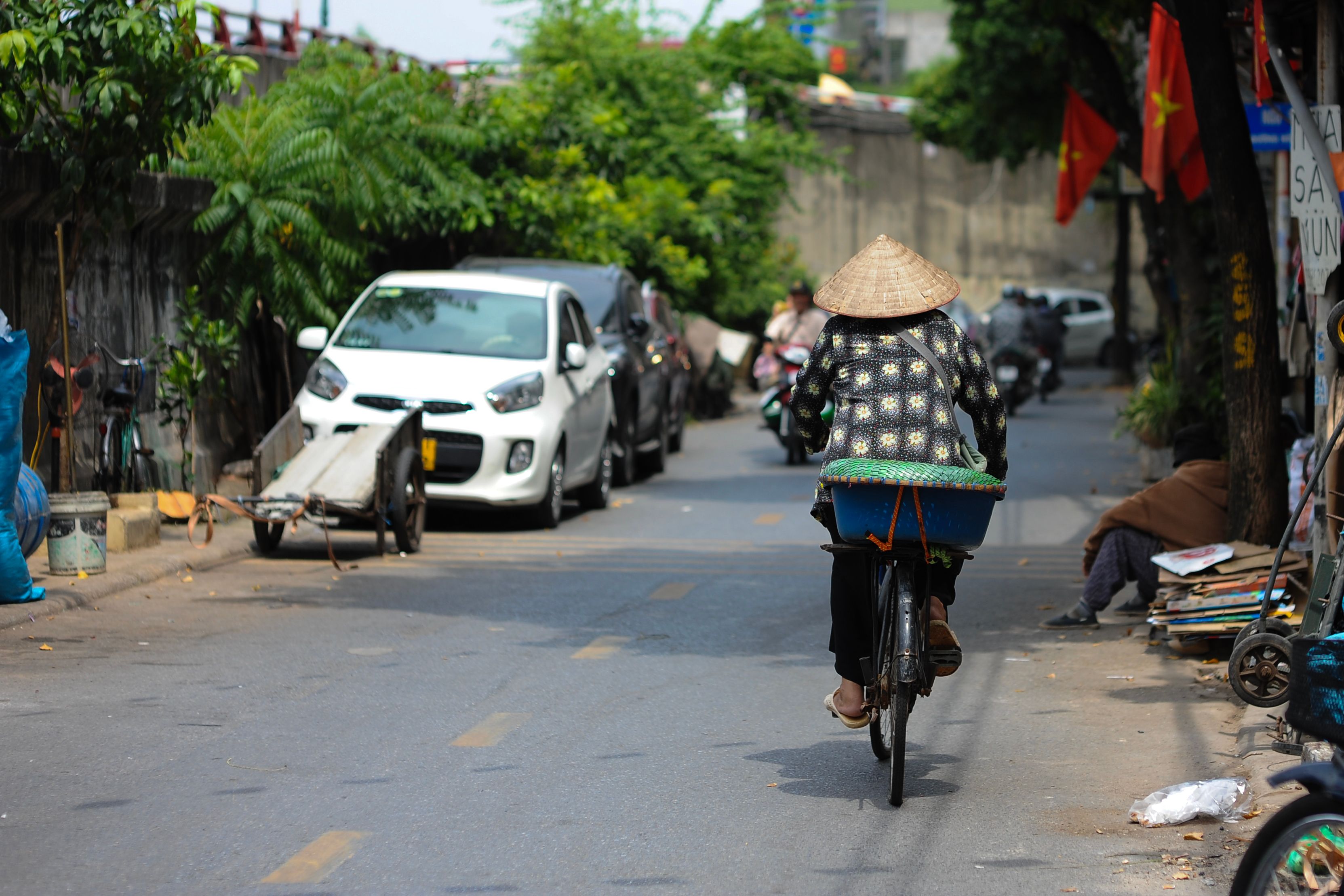 Female Cyclist in Traditional Vietnamese Street Scene · Free Stock Photo