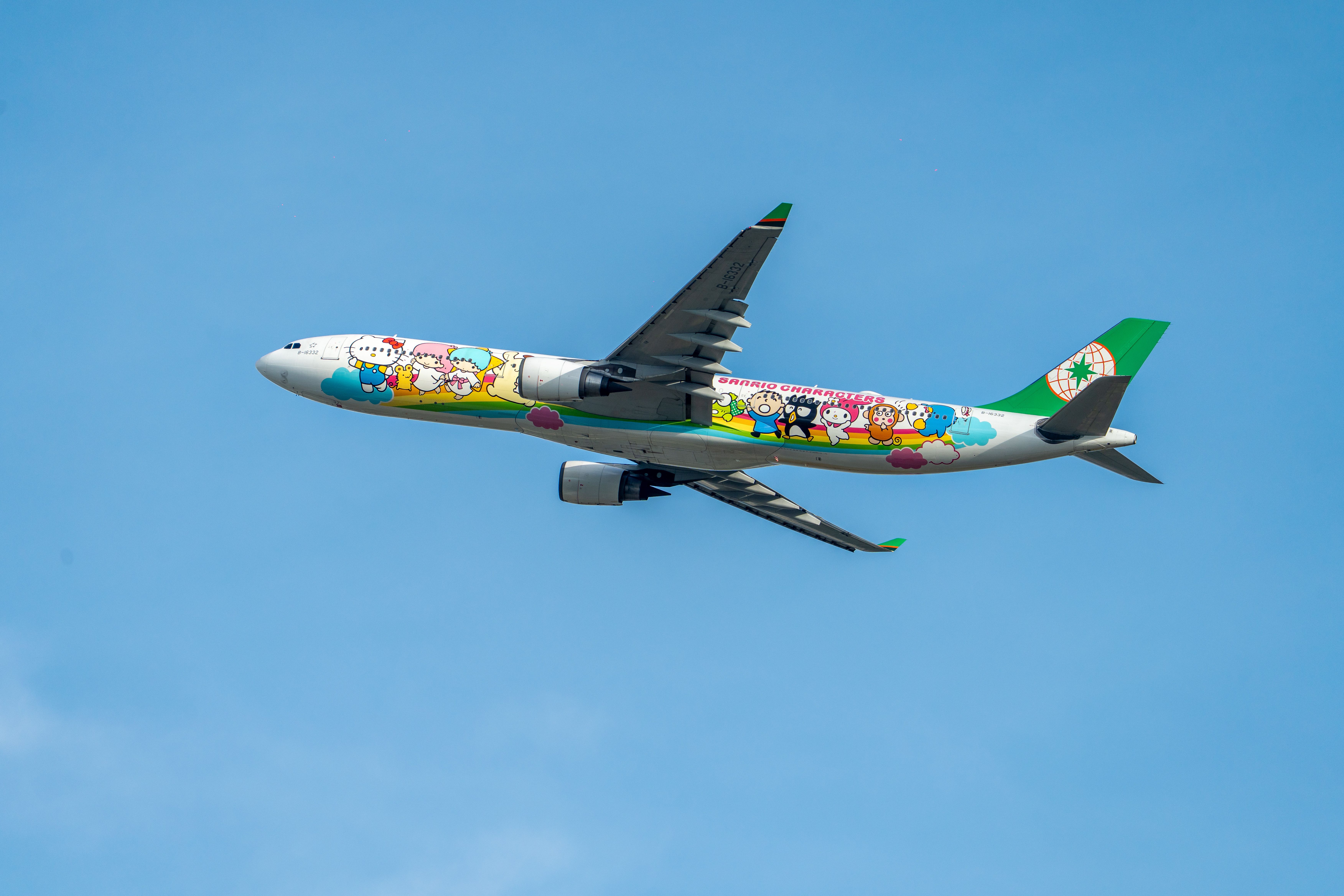 Airplane with Colorful Cartoon Livery in Flight · Free Stock Photo