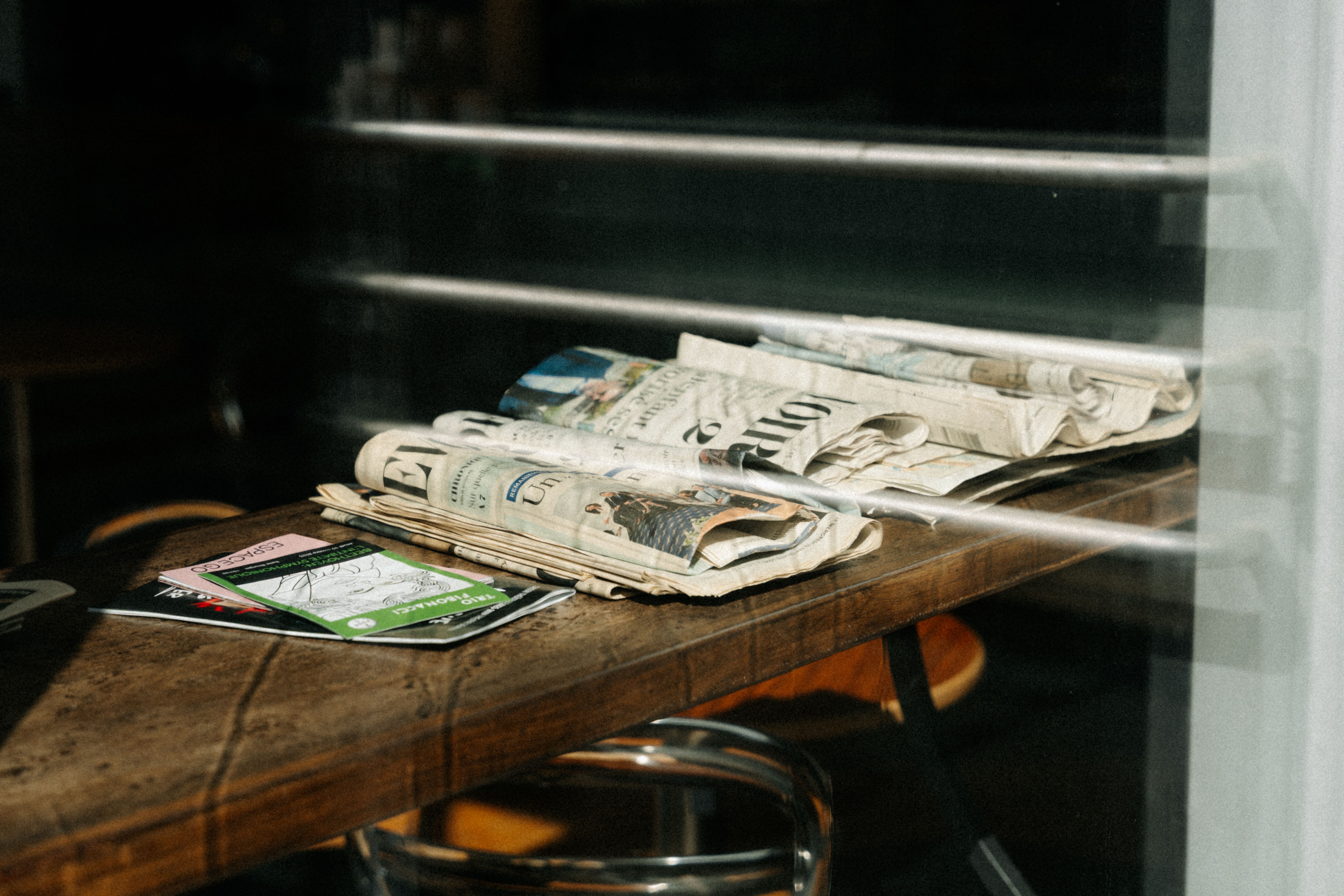 Newspapers and Magazines on a Cafe Table in Montreal · Free Stock Photo