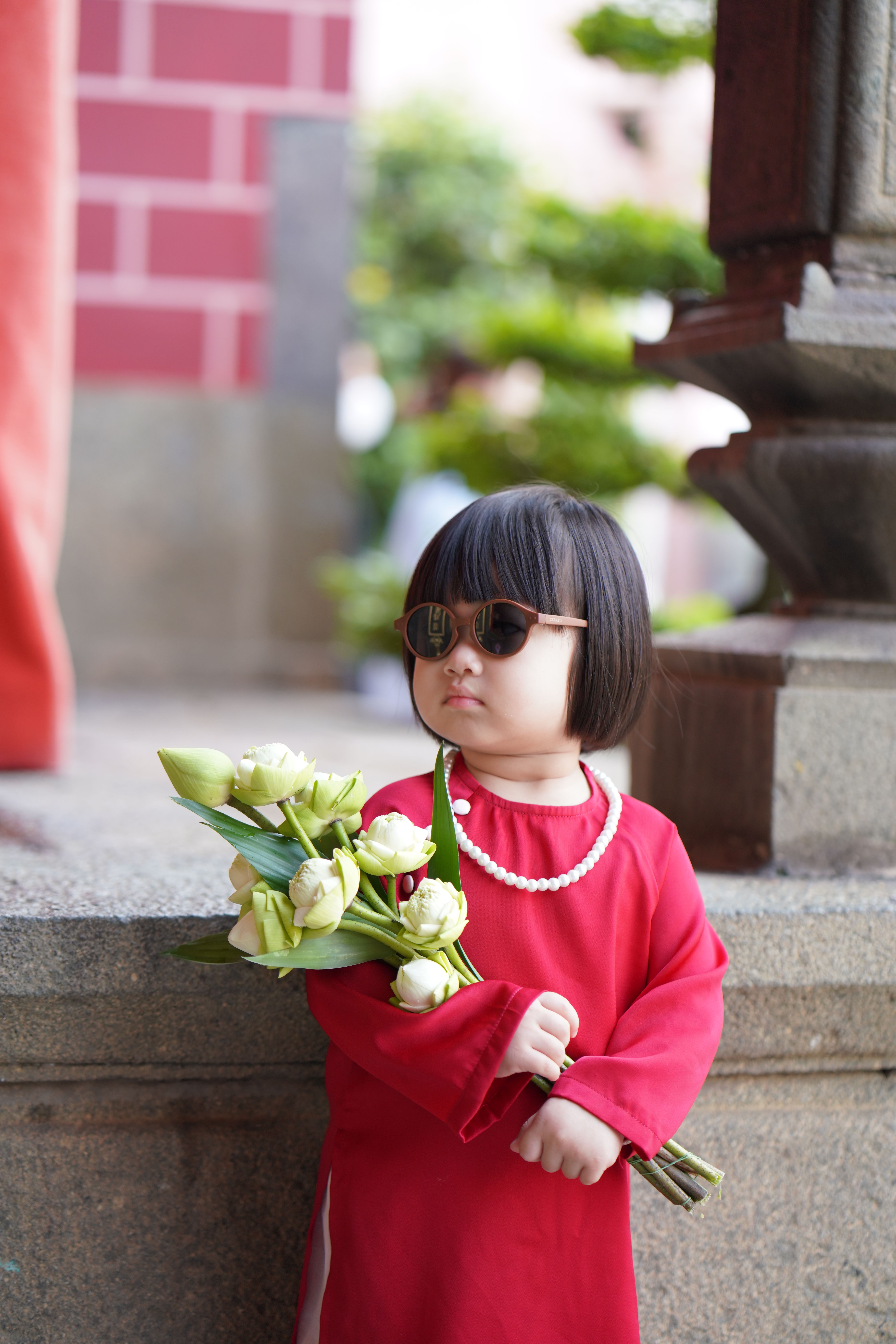 Charming Child in Red Dress Holding Flowers · Free Stock Photo