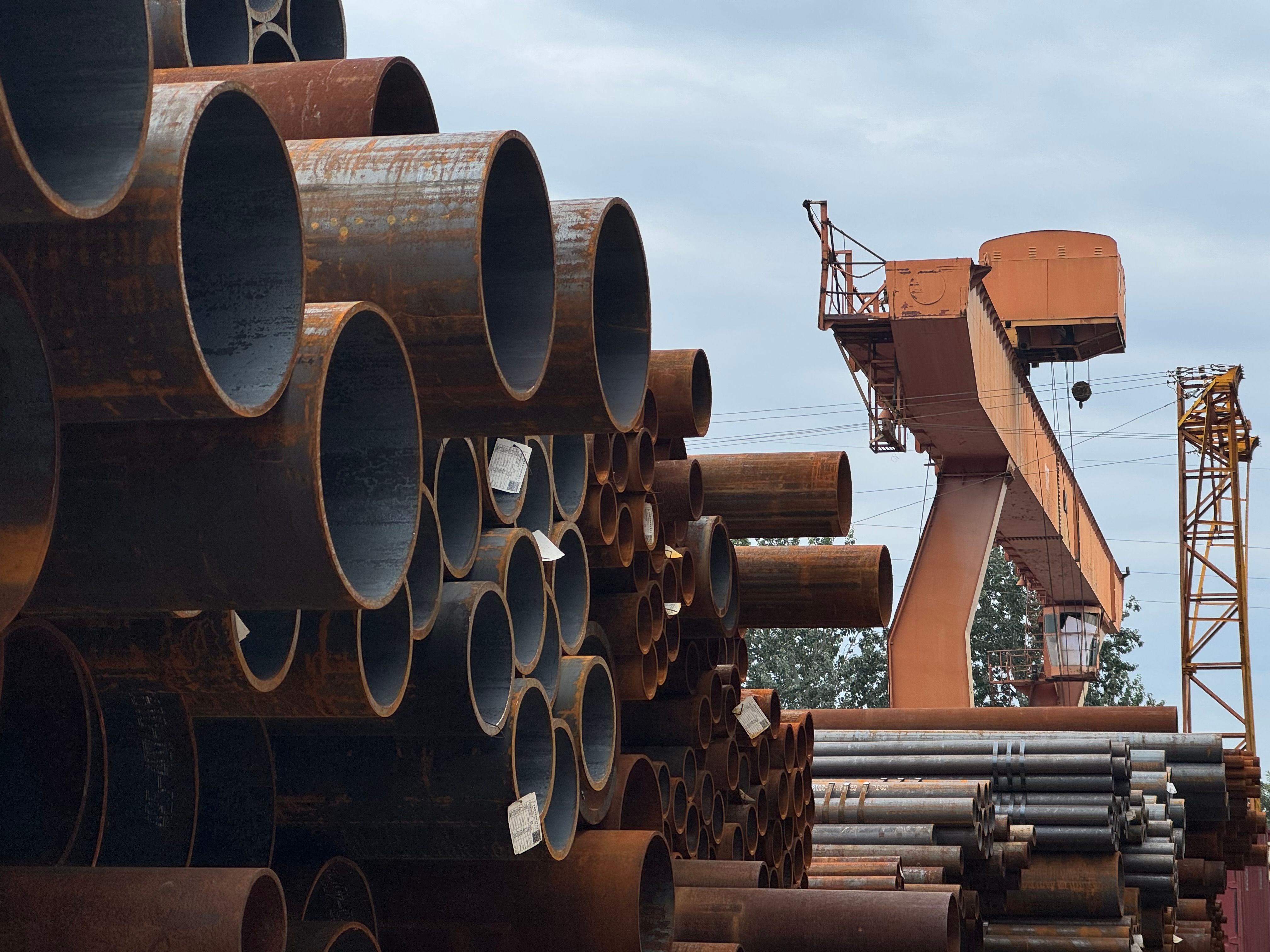 Industrial Steel Pipes with Crane in Outdoor Yard · Free Stock Photo