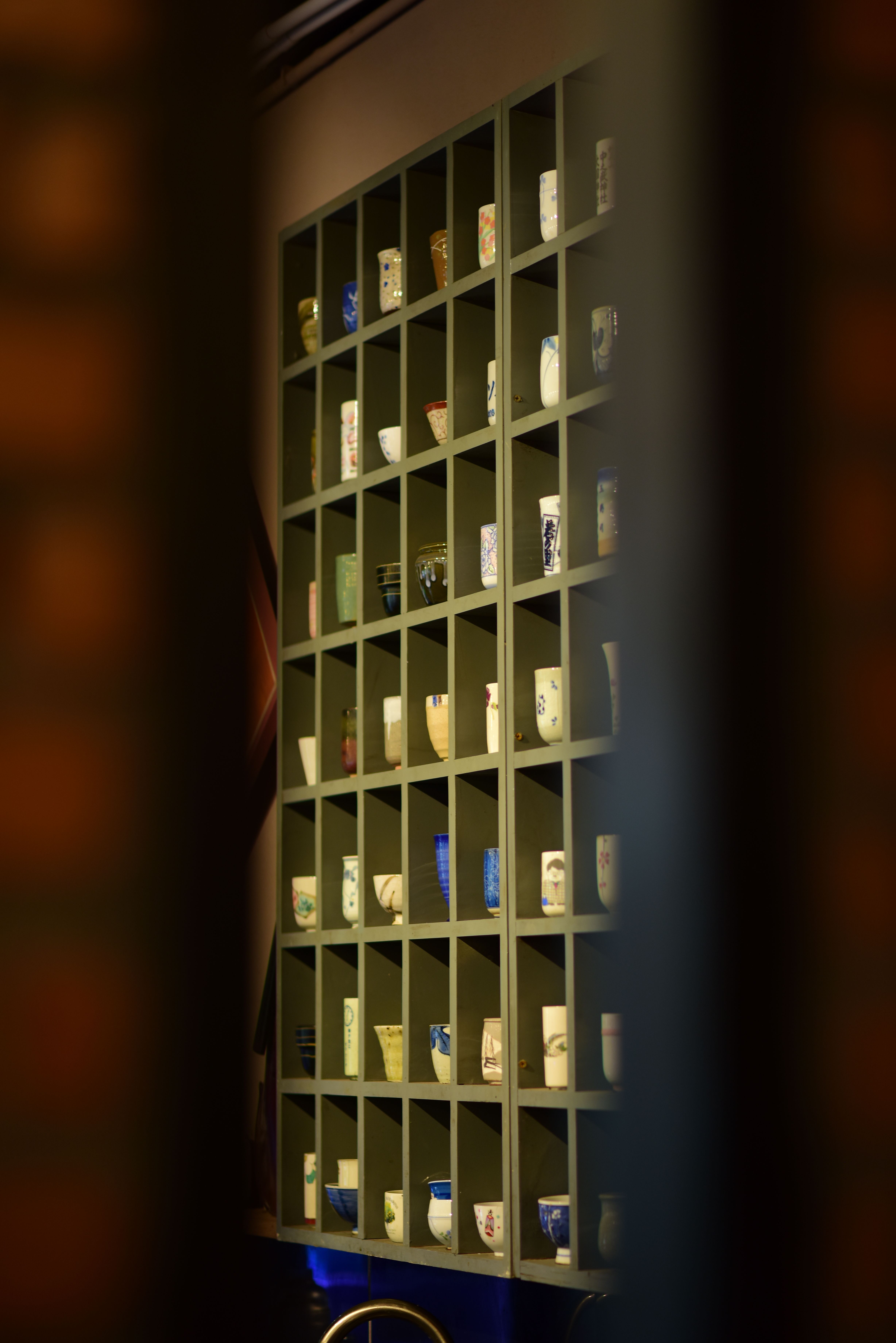 Elegant Display of Artistic Ceramic Cups on Shelf · Free Stock Photo