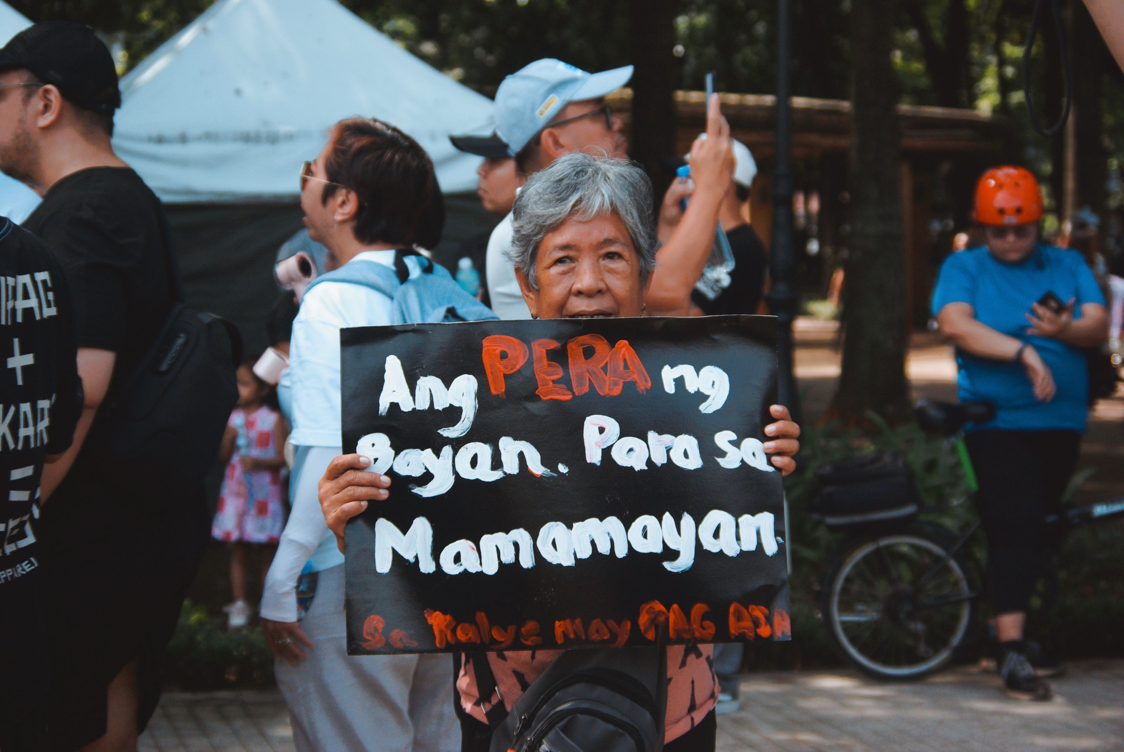 Outdoor Protest with Diverse Participants Holding Sign · Free Stock Photo