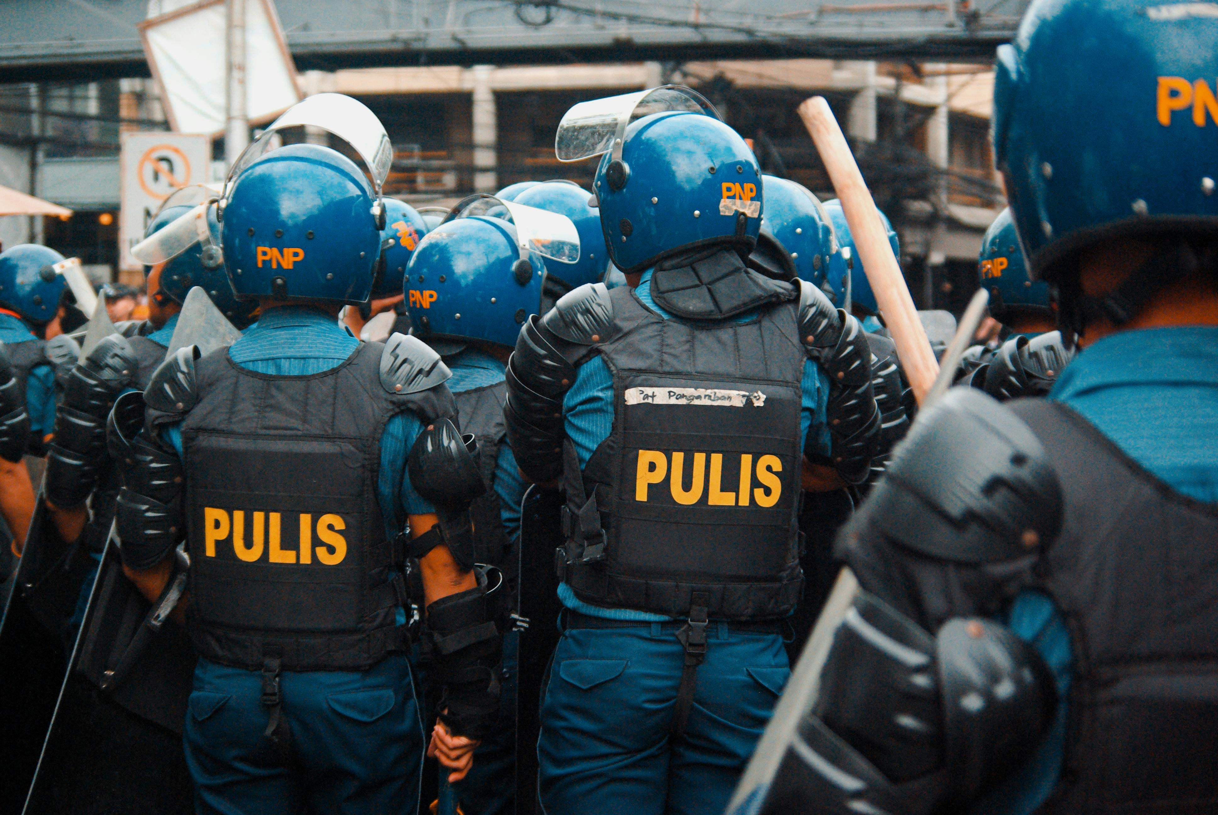 Riot Police in Formation with Helmets and Shields · Free Stock Photo