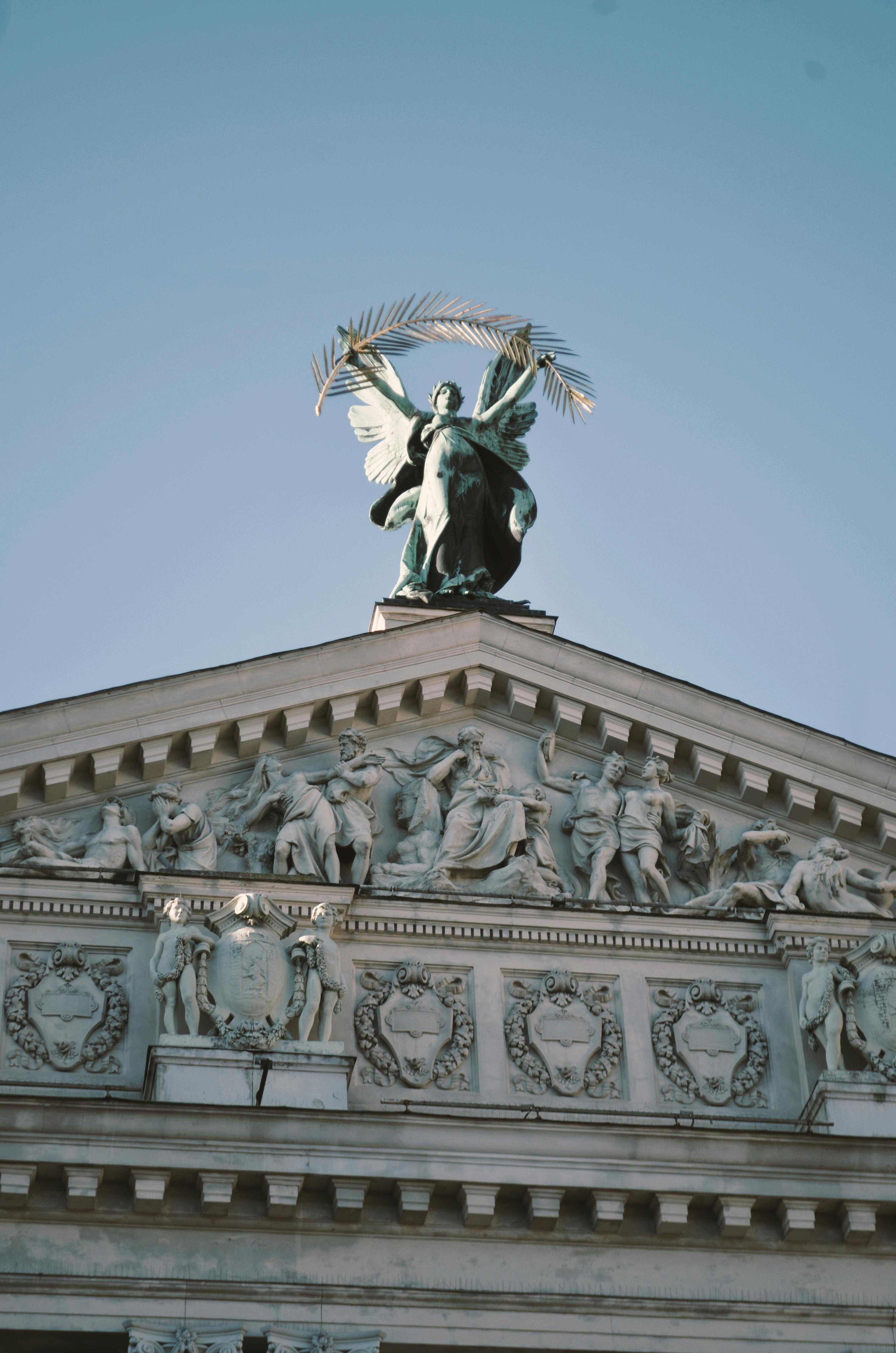 Ornate Architectural Sculpture on Building Facade · Free Stock Photo