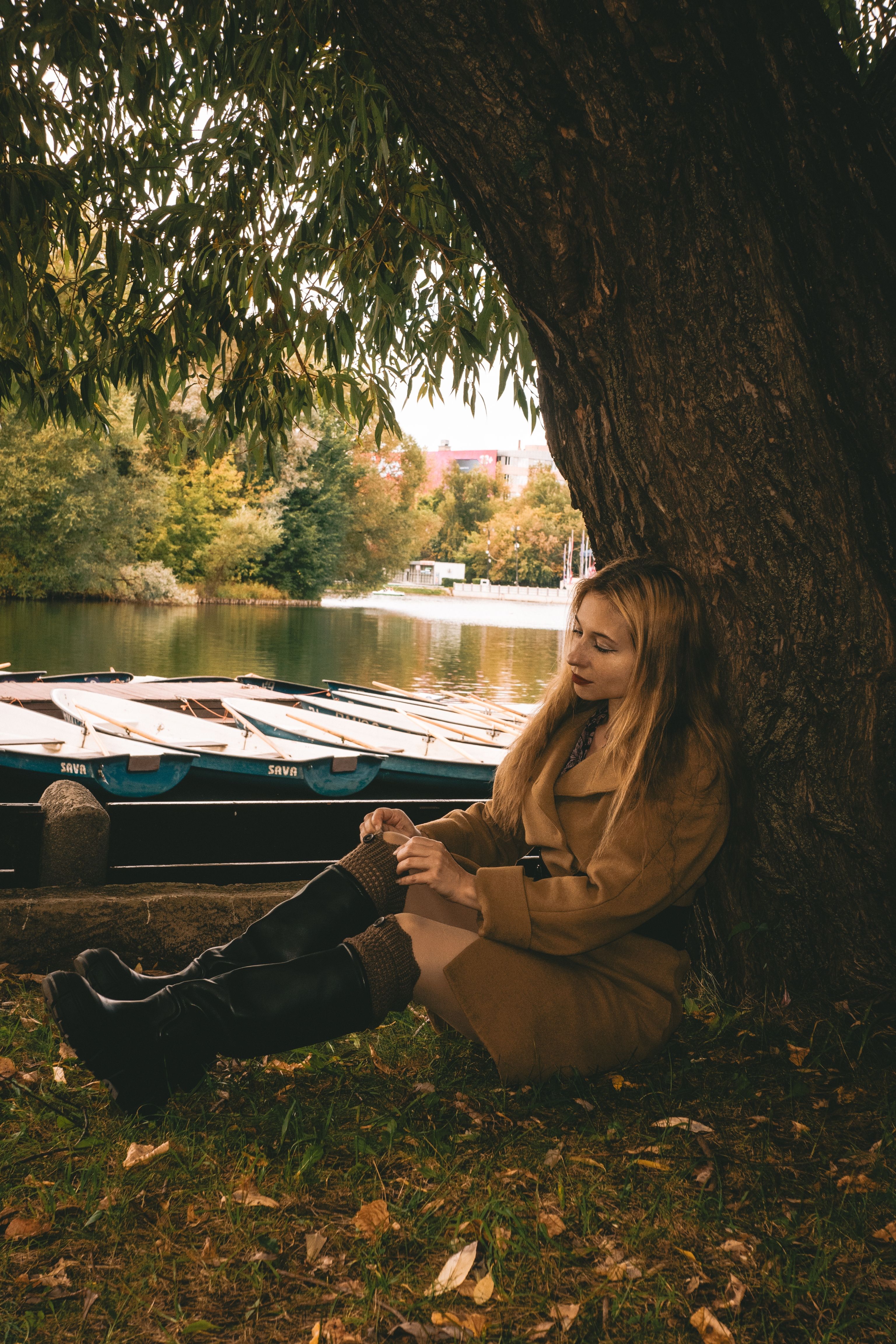 Woman Relaxing Under Tree by Serene Lake · Free Stock Photo