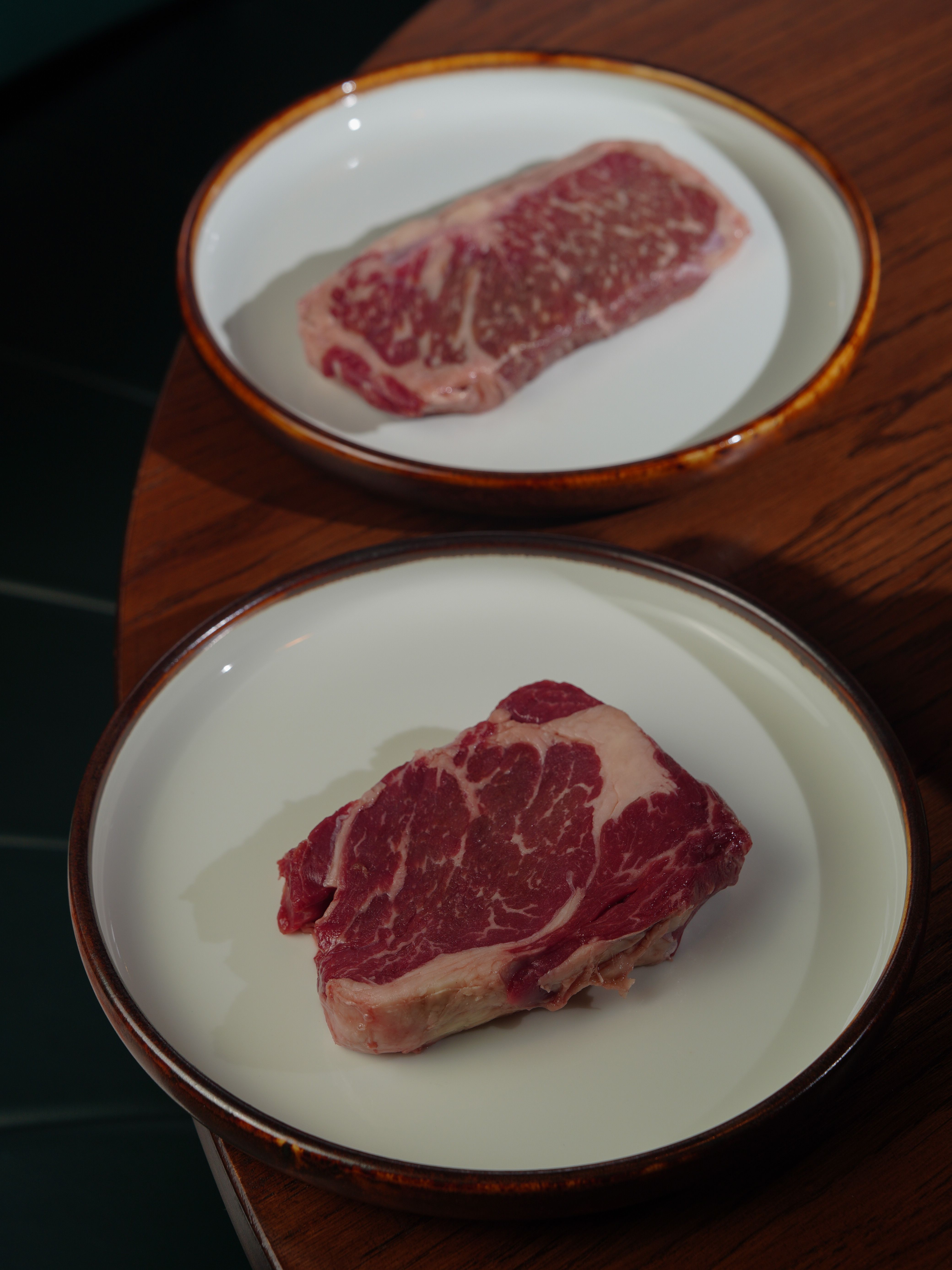 Top View of Raw Steak Cuts on Plates · Free Stock Photo