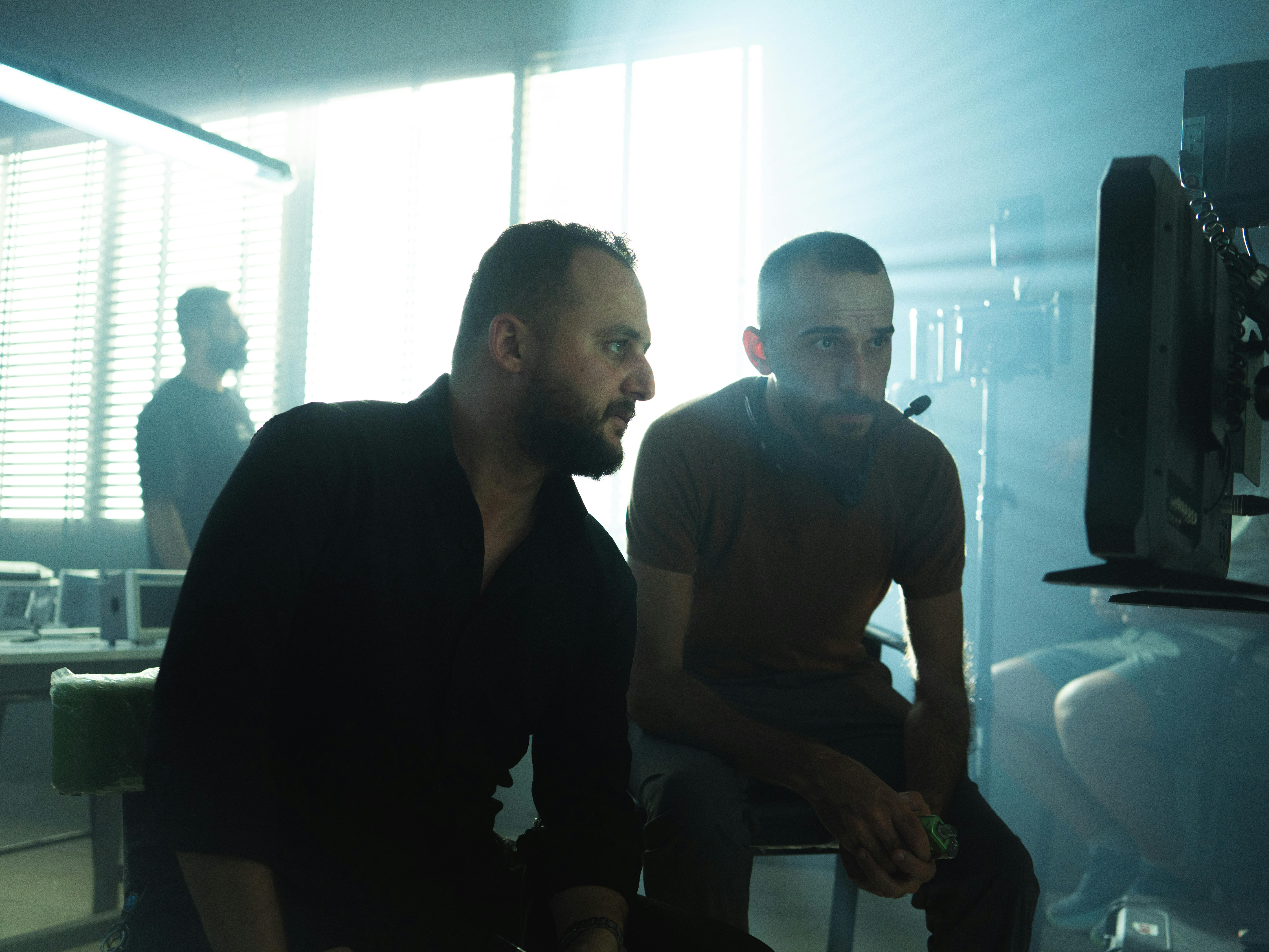 Film Crew Members Working in Studio Setting · Free Stock Photo