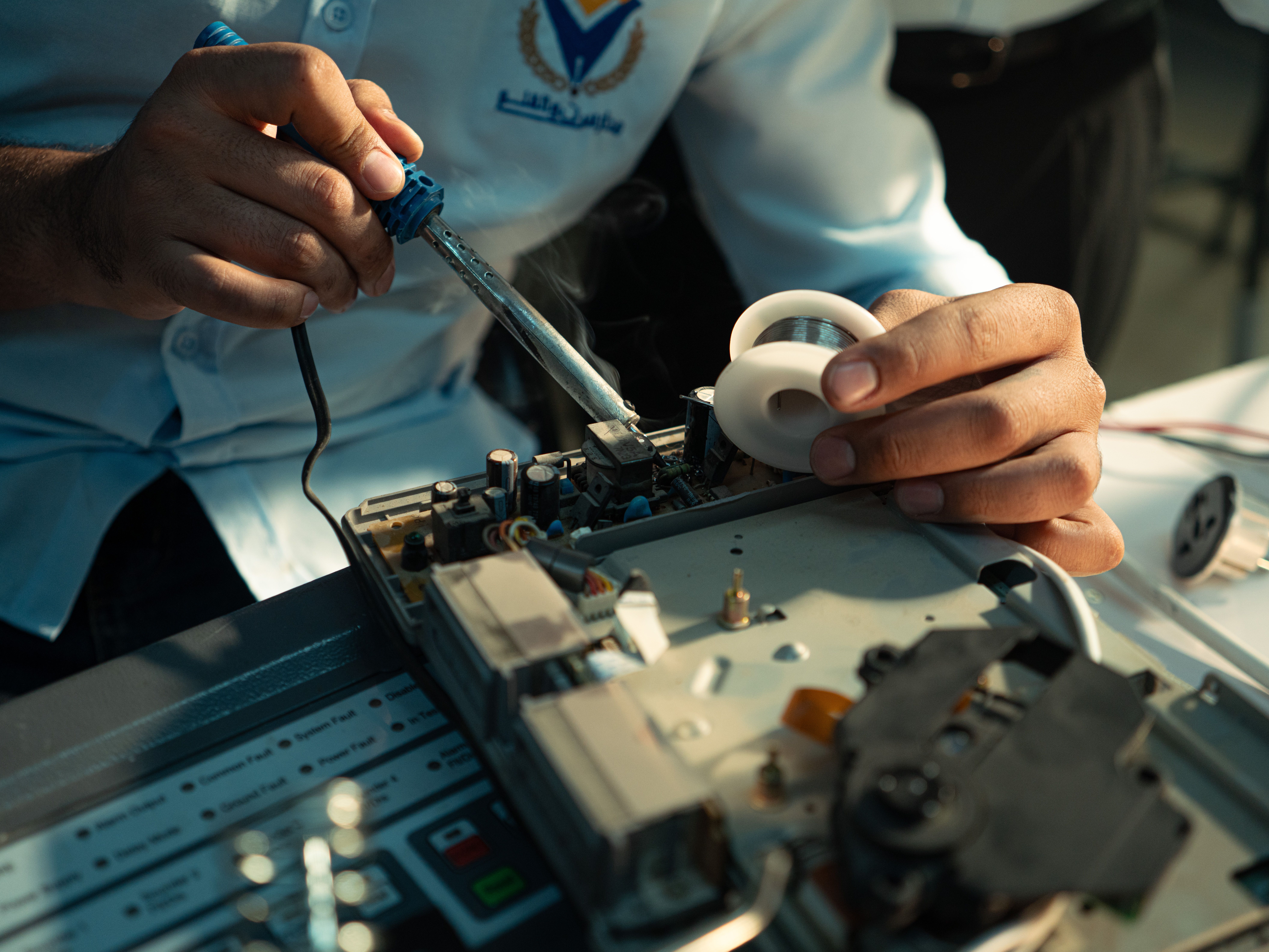 Close-Up of Hands Soldering Electronic Circuit Board · Free Stock Photo