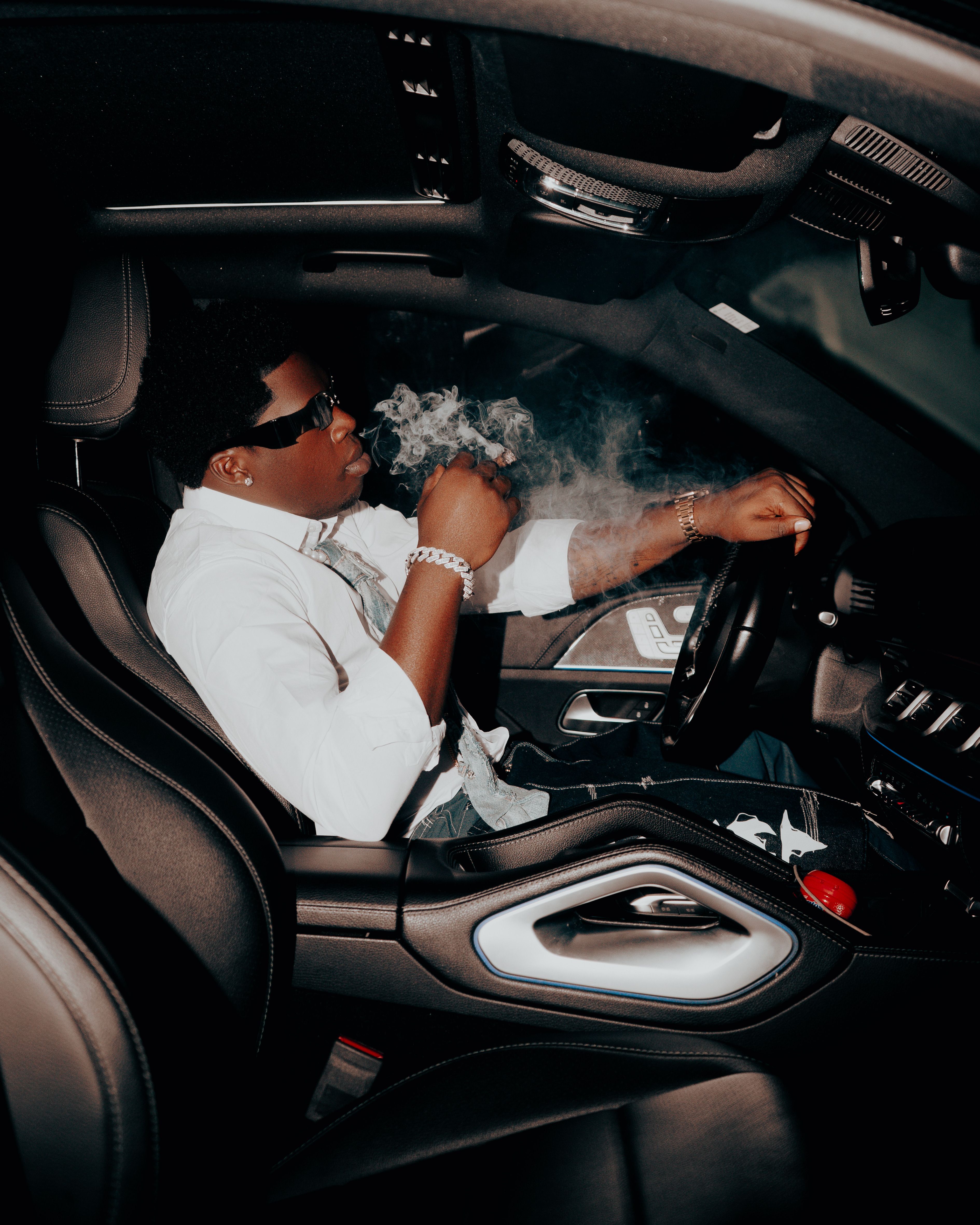 Man Smoking Inside Luxury Car Interior at Night · Free Stock Photo