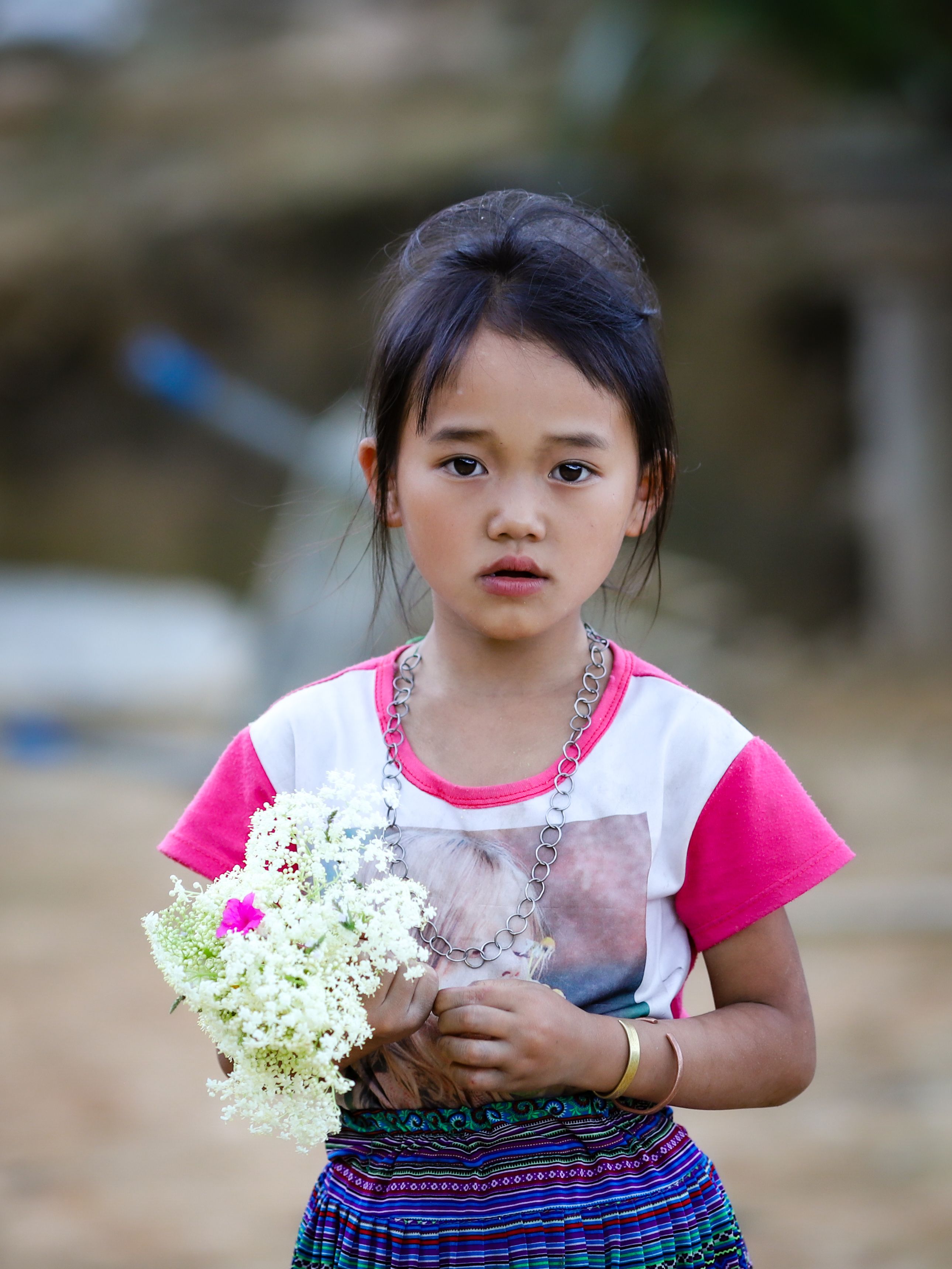 Portrait of Hmong Child Holding Flowers in Vietnam · Free Stock Photo
