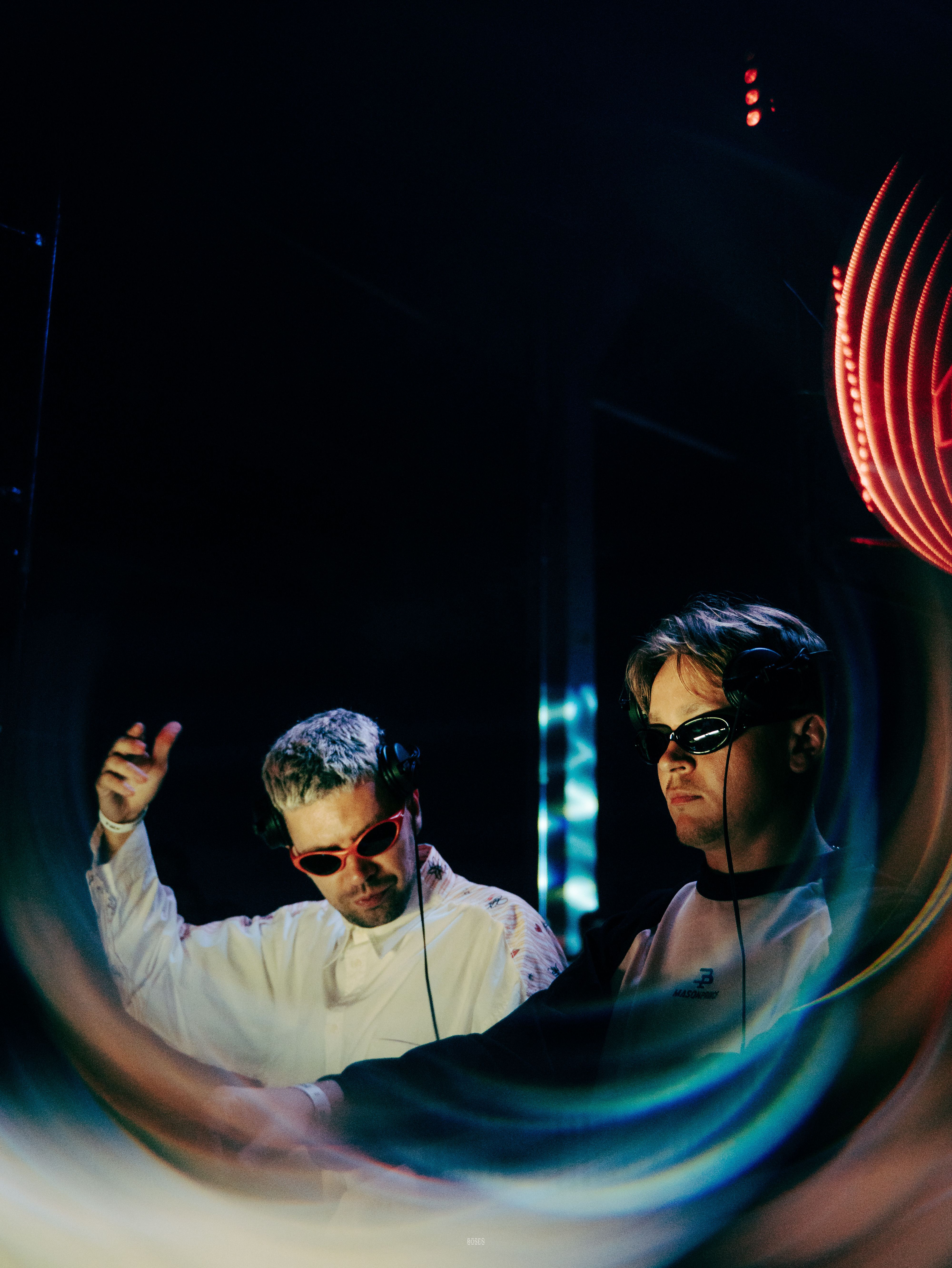 Dynamic DJ Duo Performing in Vibrant Club · Free Stock Photo