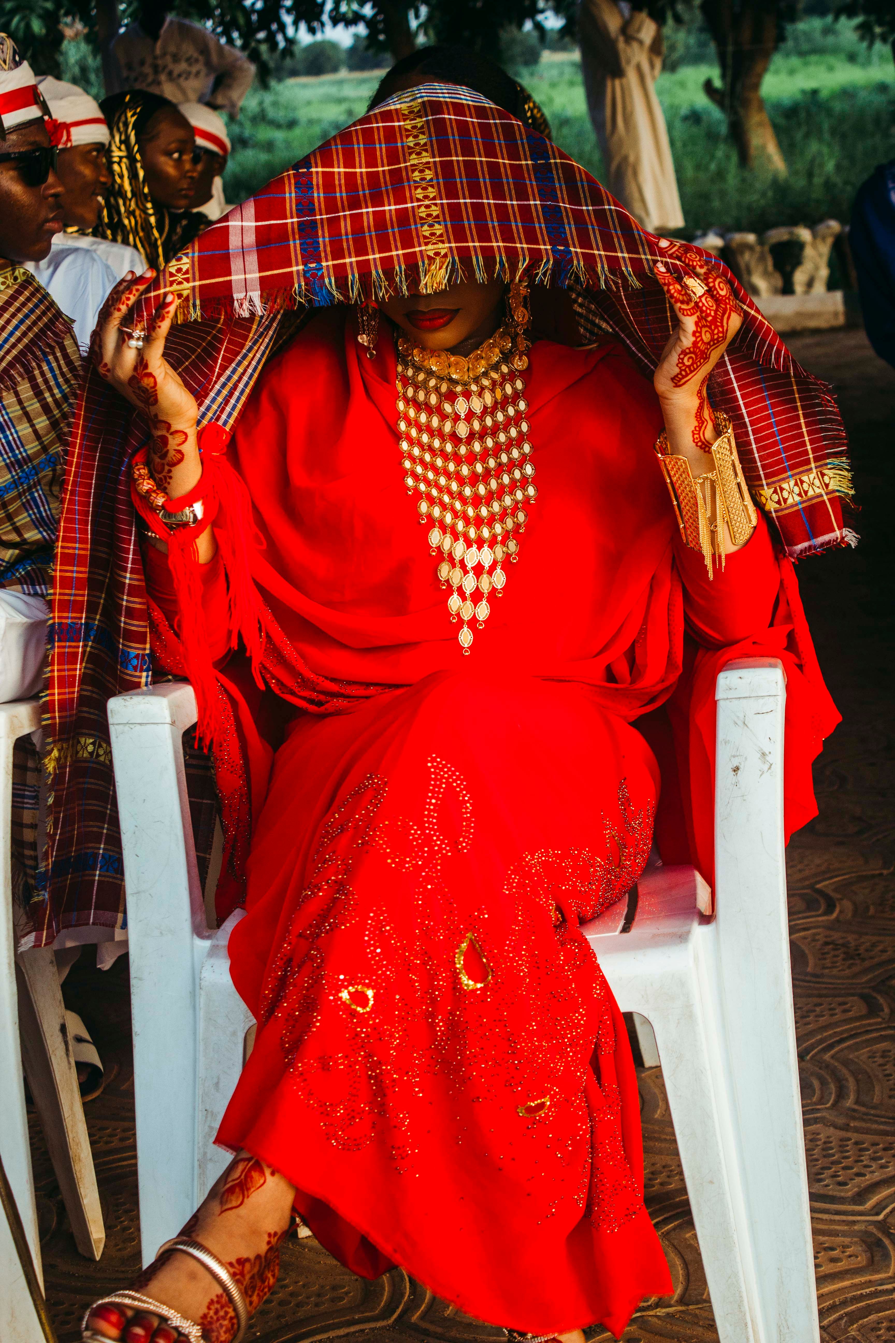 Traditional Ceremony Woman in Vibrant Red Attire · Free Stock Photo