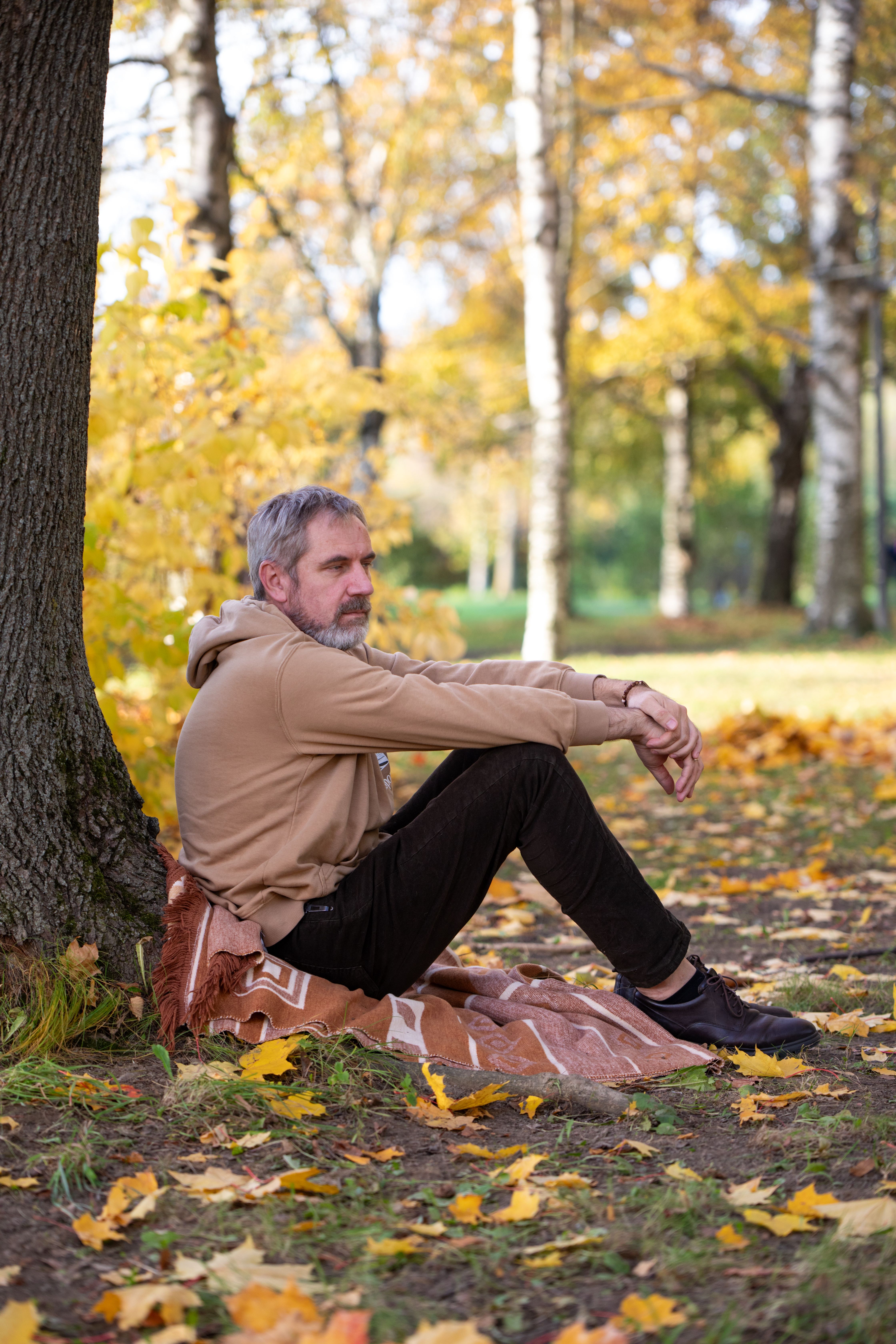 Autumn Serenity: Man Relaxing Under Tree · Free Stock Photo