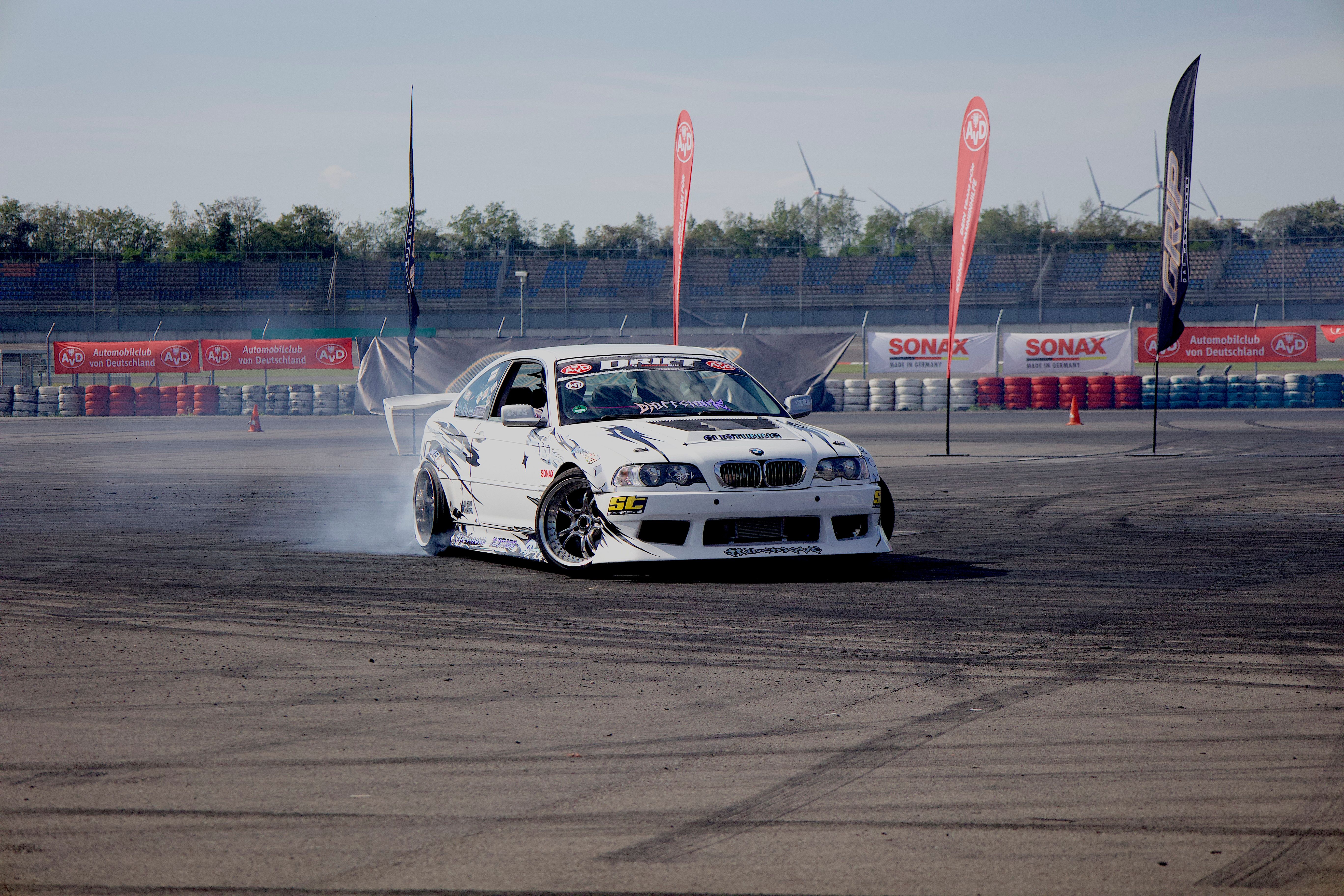 Dynamic BMW Drift Car on Race Track · Free Stock Photo