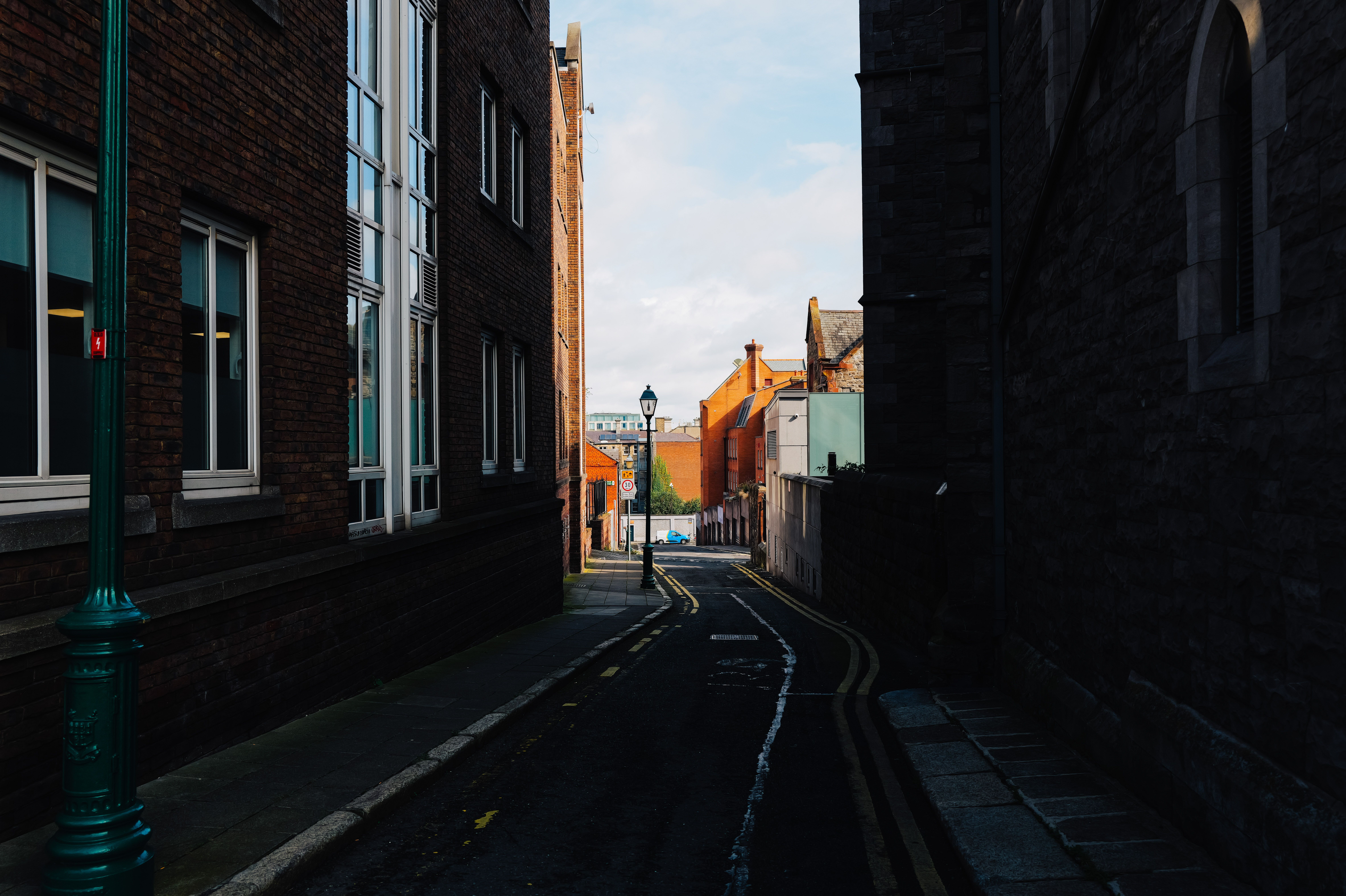 Charming European Alley with Brick Buildings · Free Stock Photo